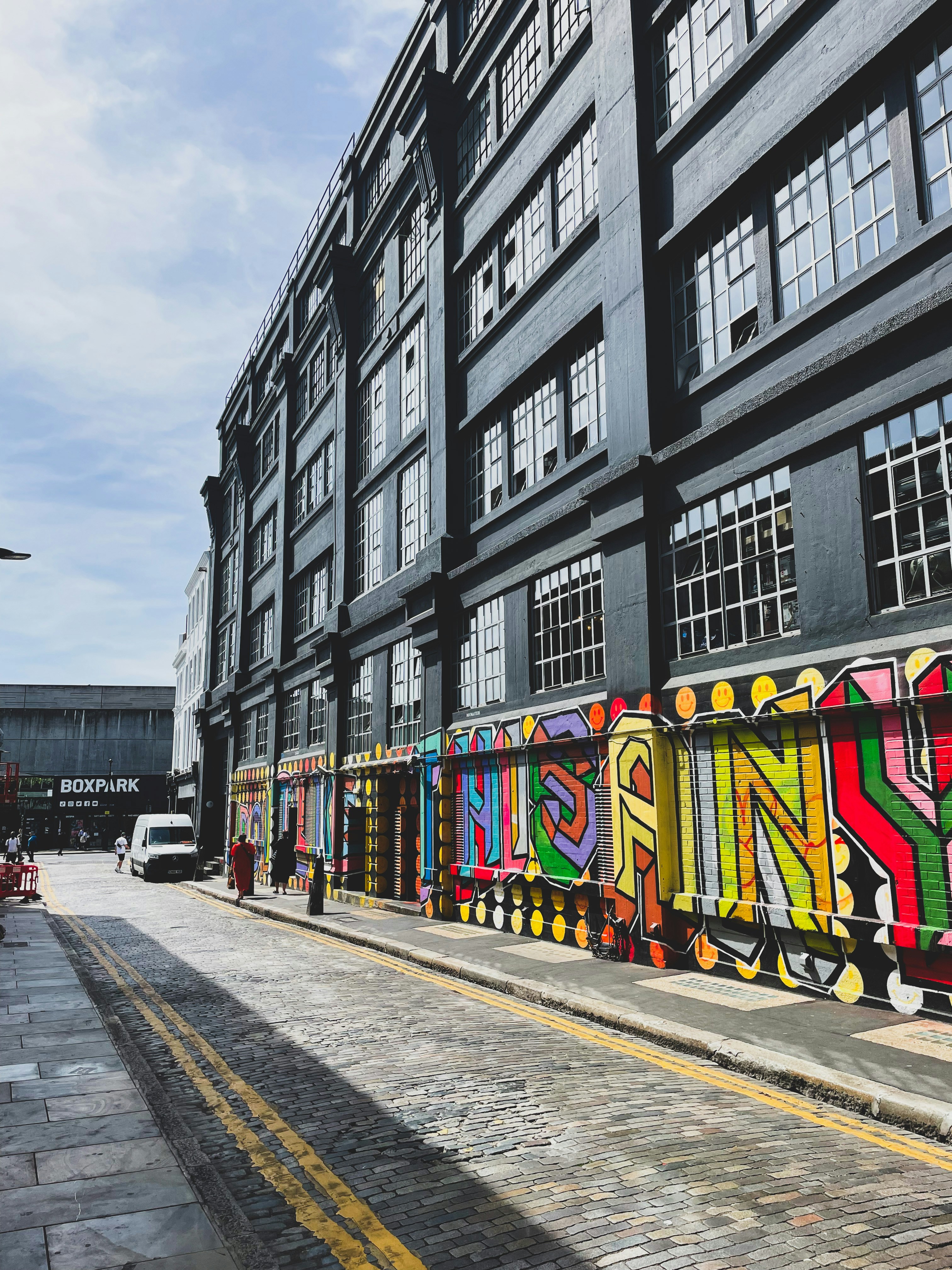 Chromatic Chronicle: Graffiti Letters Span a Brick Factory Facade