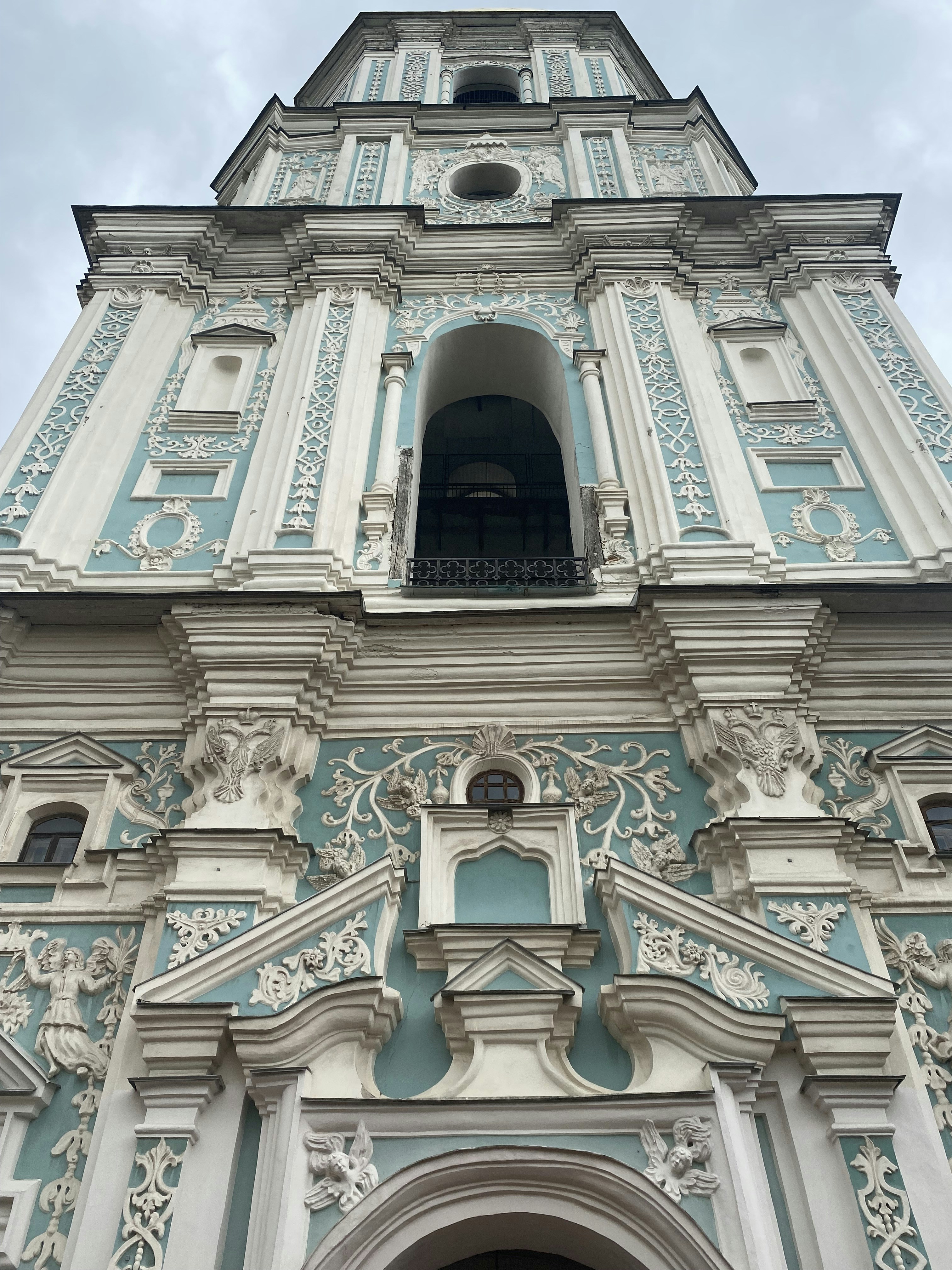 Intricate façade of a historic building showcasing ornate carvings and a striking blue and white color scheme.
