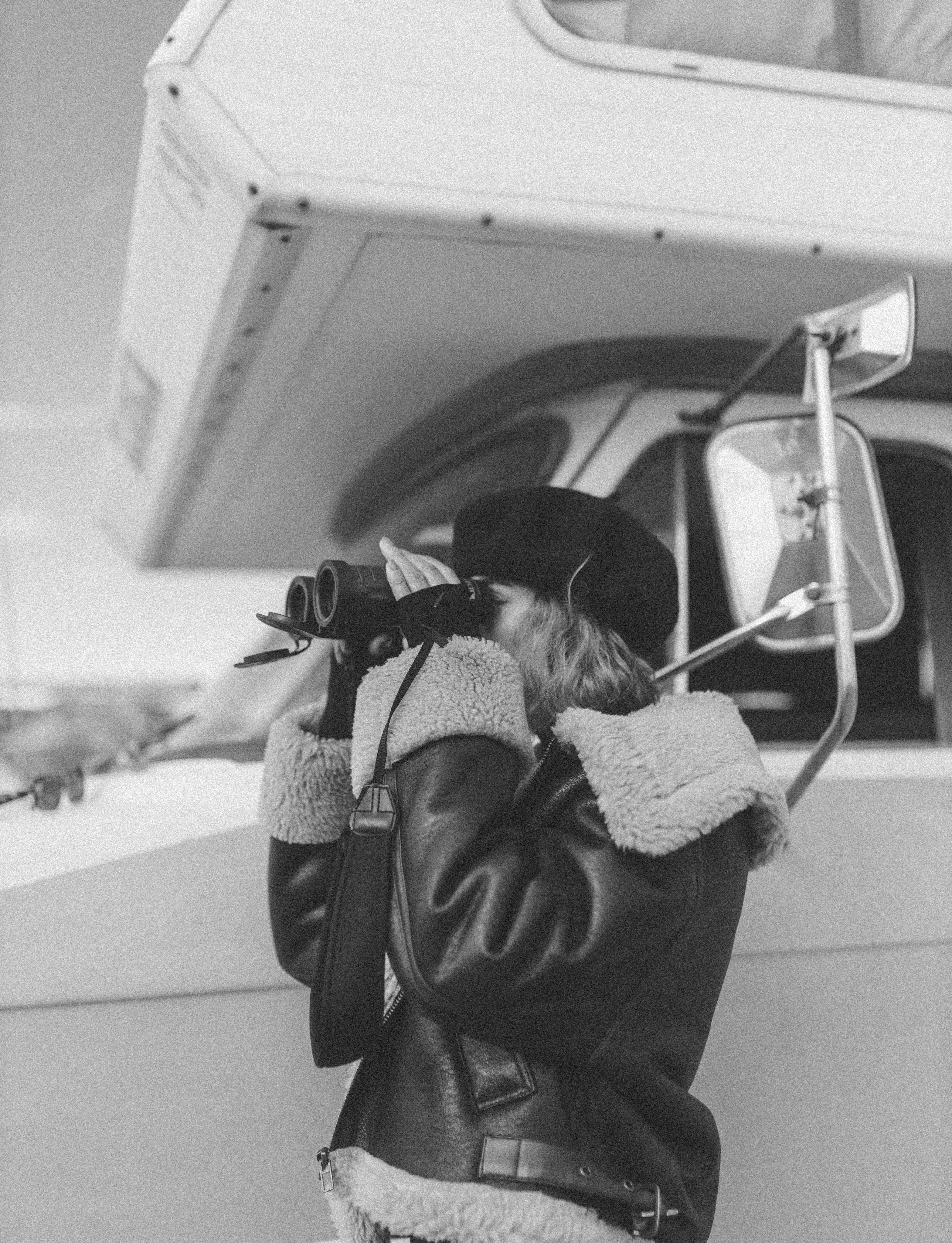 a man in a leather jacket taking a picture of himself