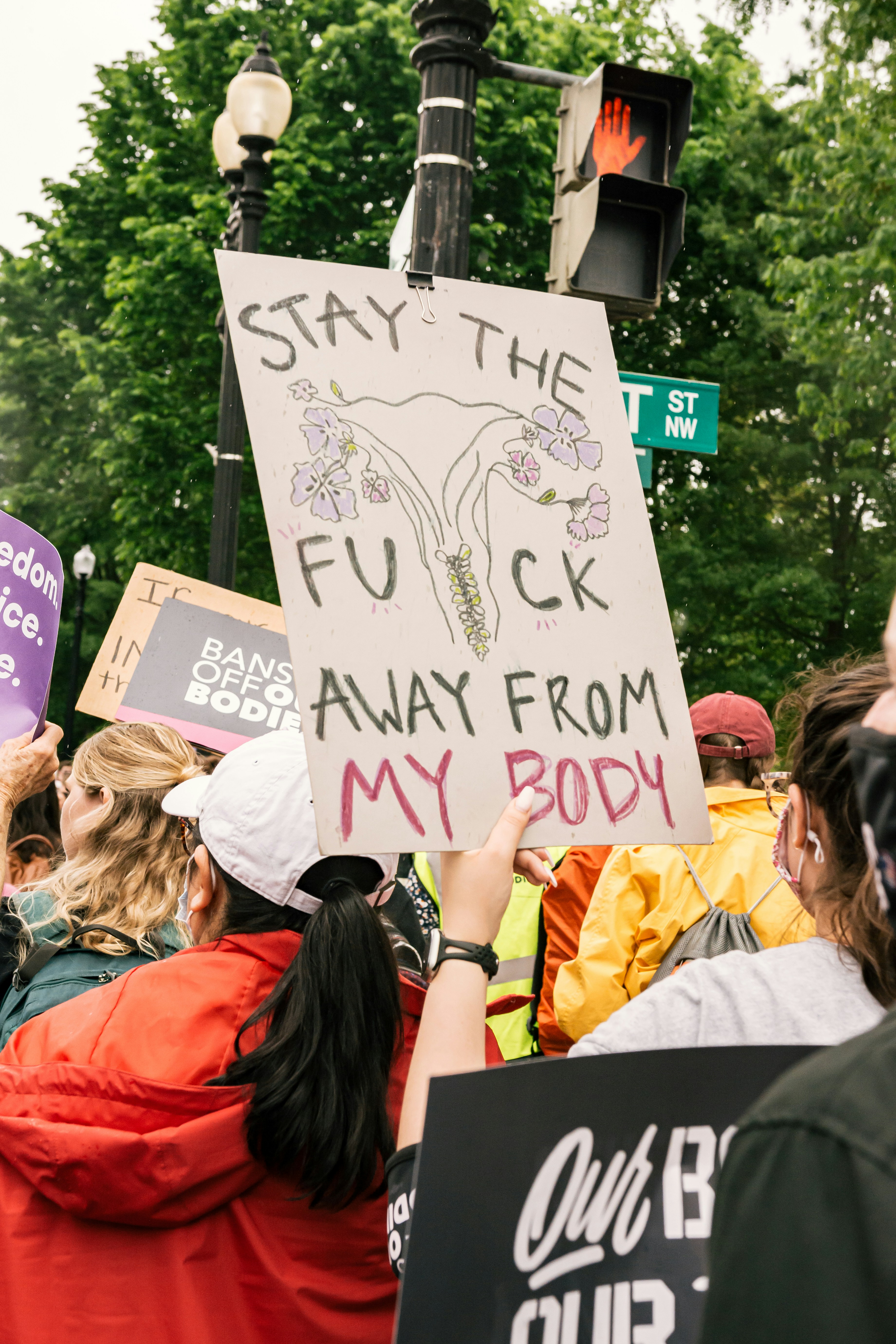 A group of people holding signs in the street photo – Free Supreme ...