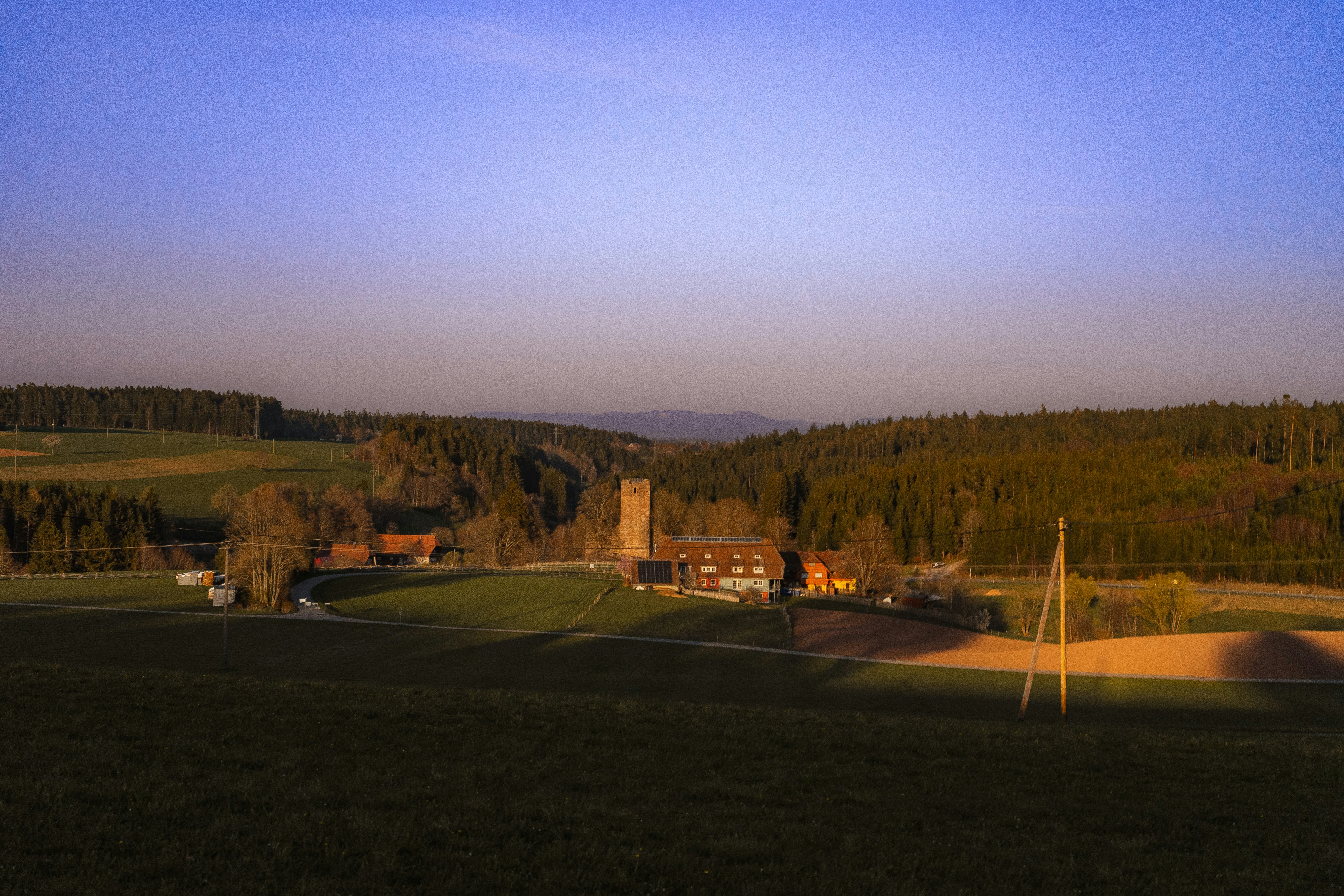 Village Horizon: Dusk Beneath the Quiet Slope