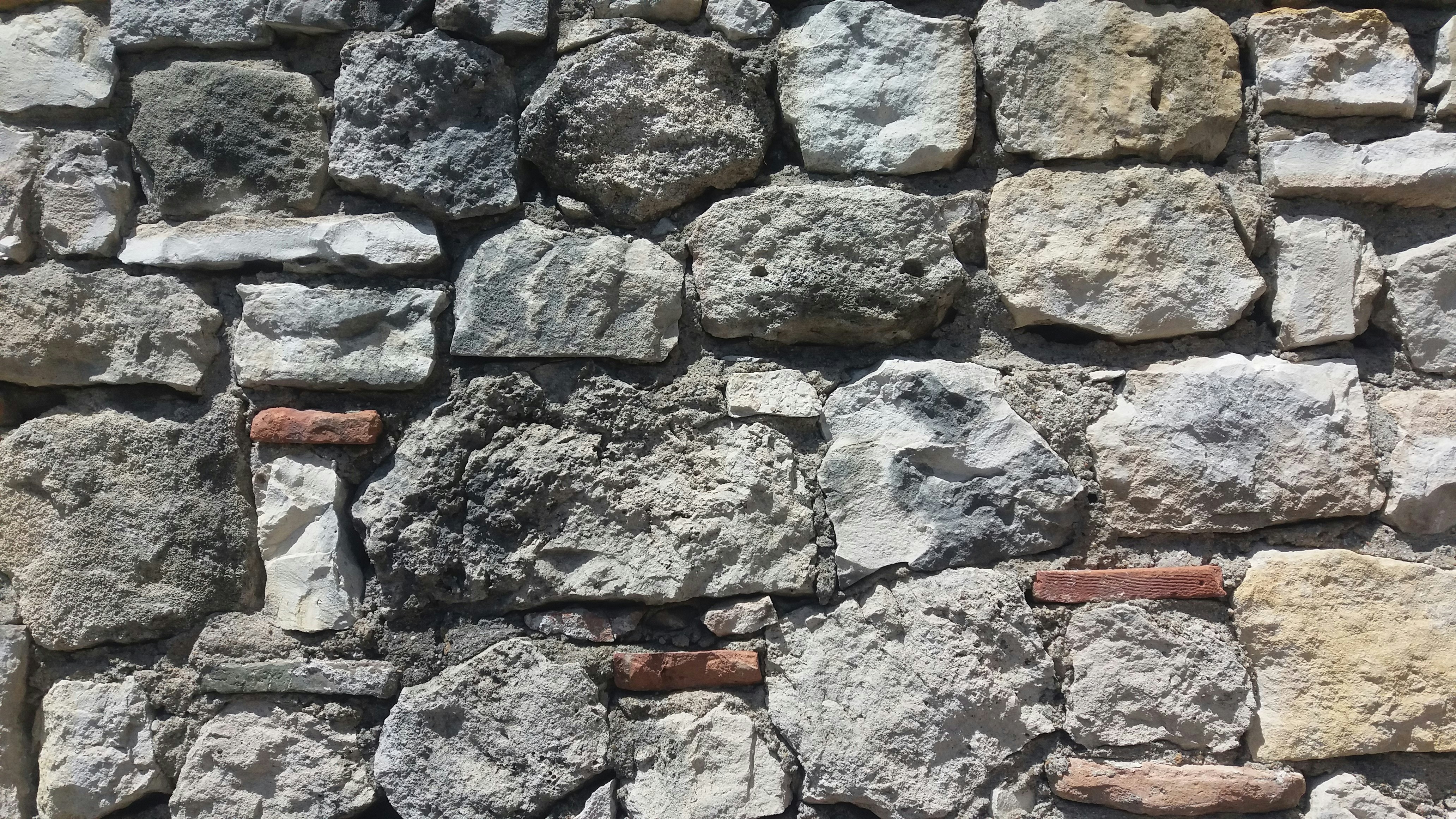 Foto Un primer plano de un muro de piedra hecho de rocas – Imagen Gris ...