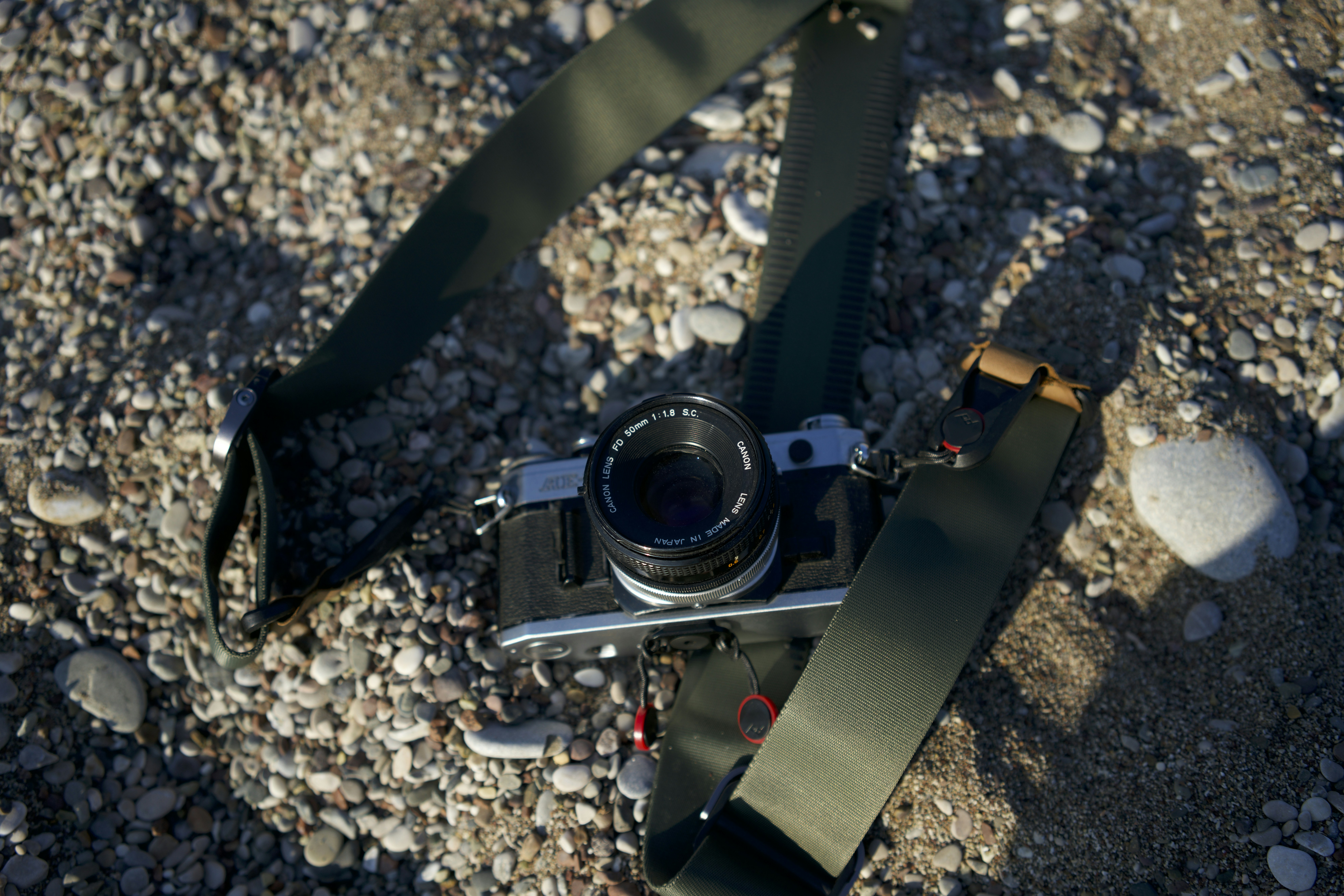 Pebbles, Strap, and a Silent Lens: A Vintage 35mm SLR on Gravel