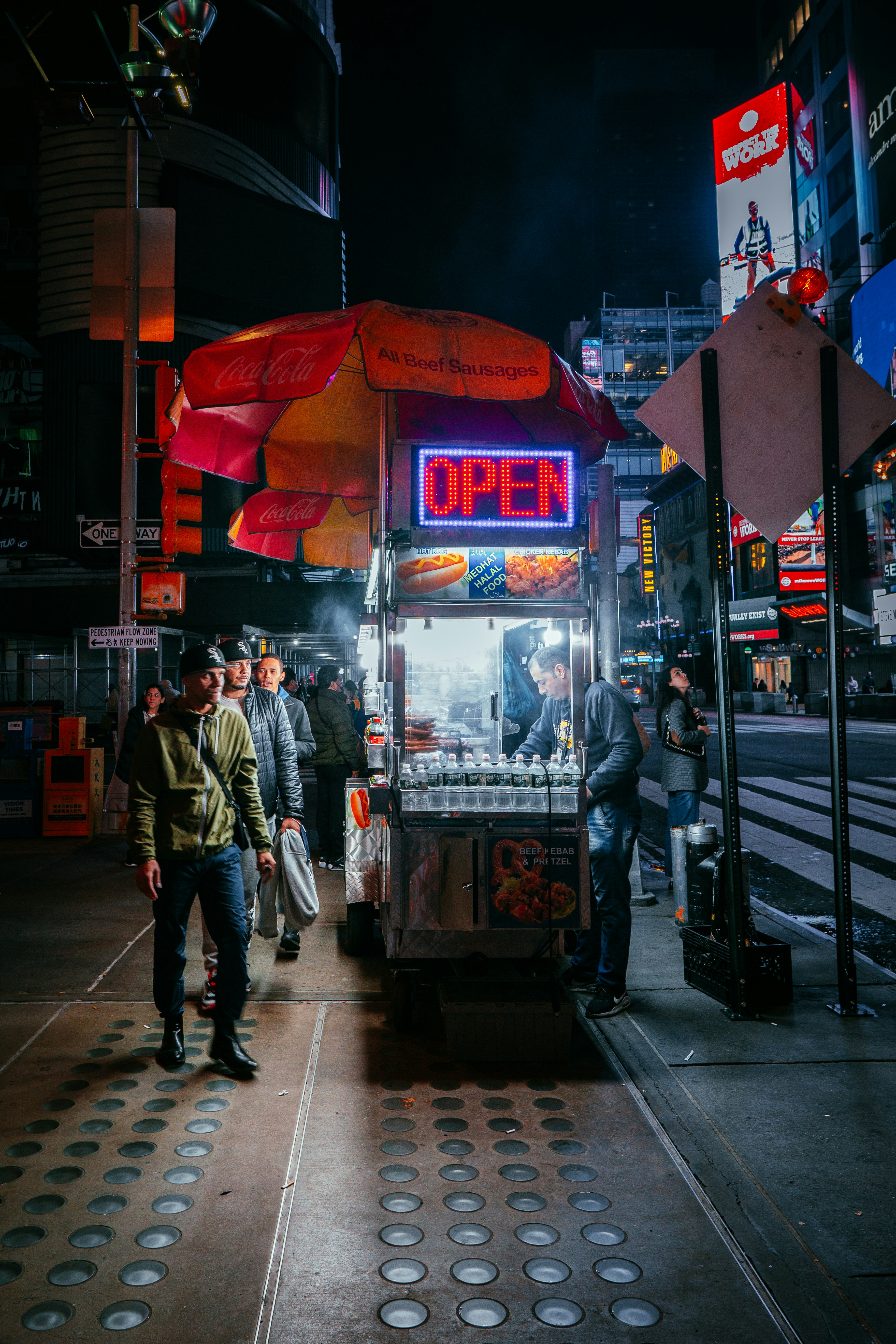OPEN Neon at Night: A Street Cart Illuminates a Bustling City Block