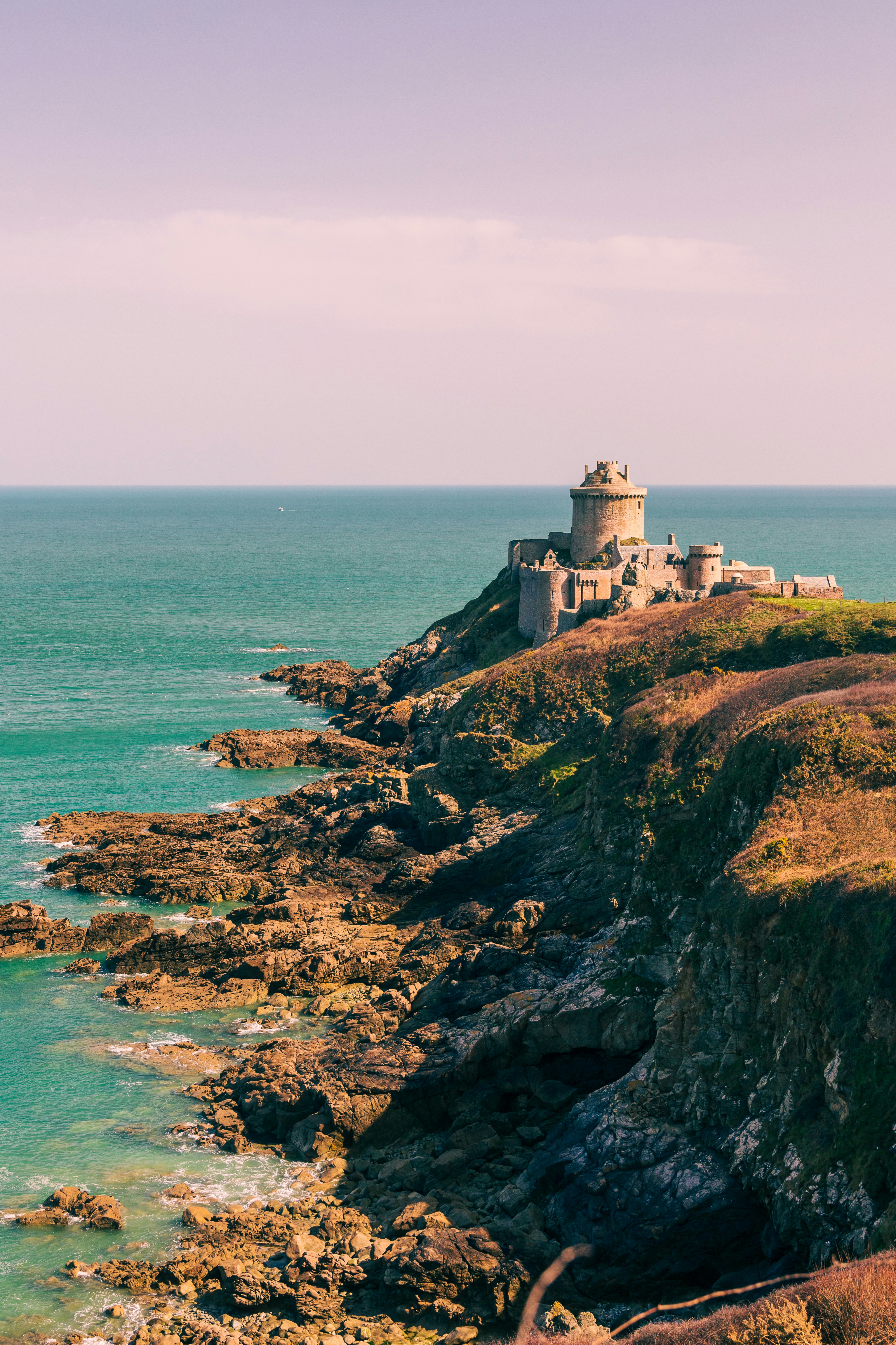 Harbor's Edge Fortress: A Cliffside Keep Over Turquoise Seas
