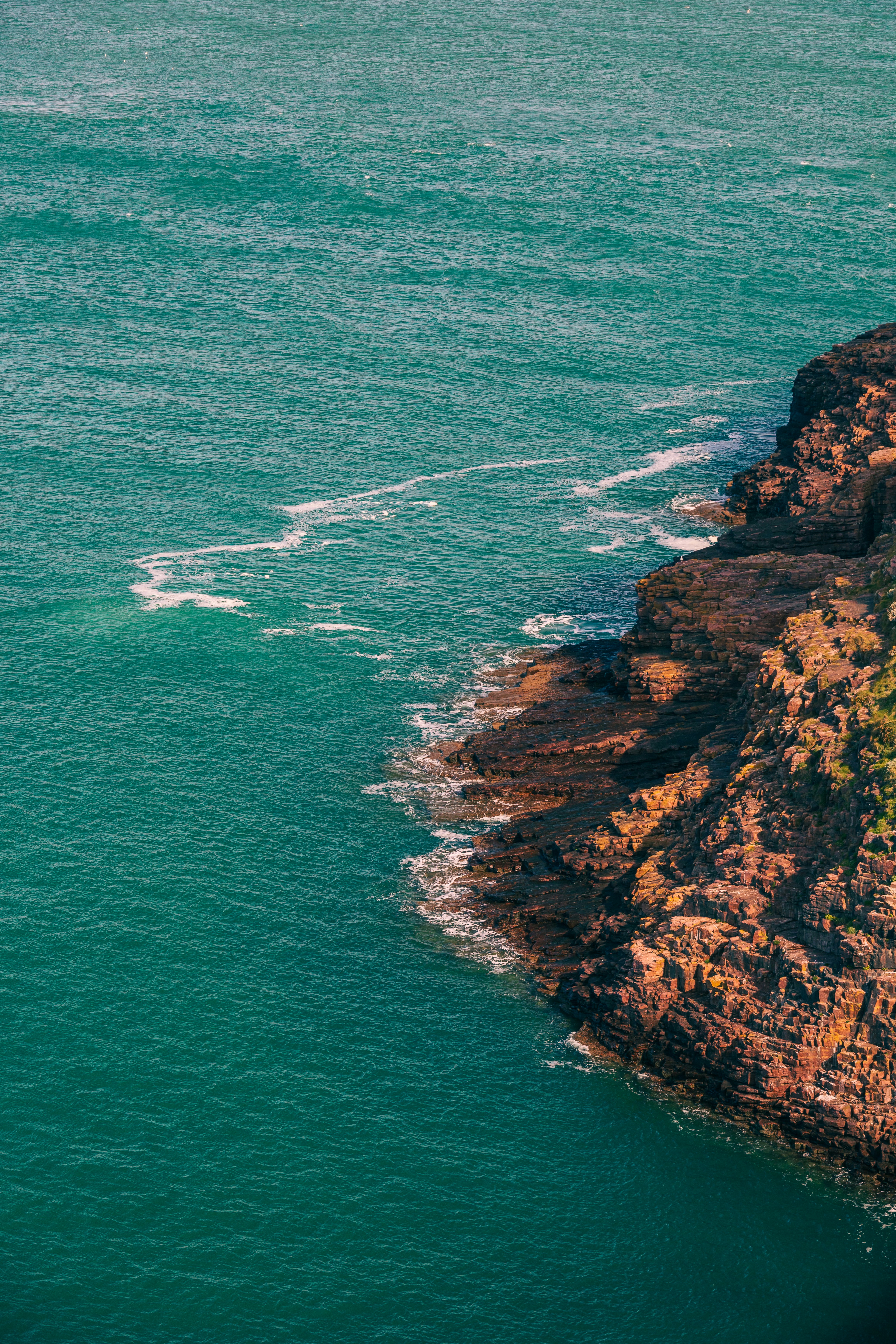 A boat is out on the water near a cliff photo – Free Cap fréhel Image ...