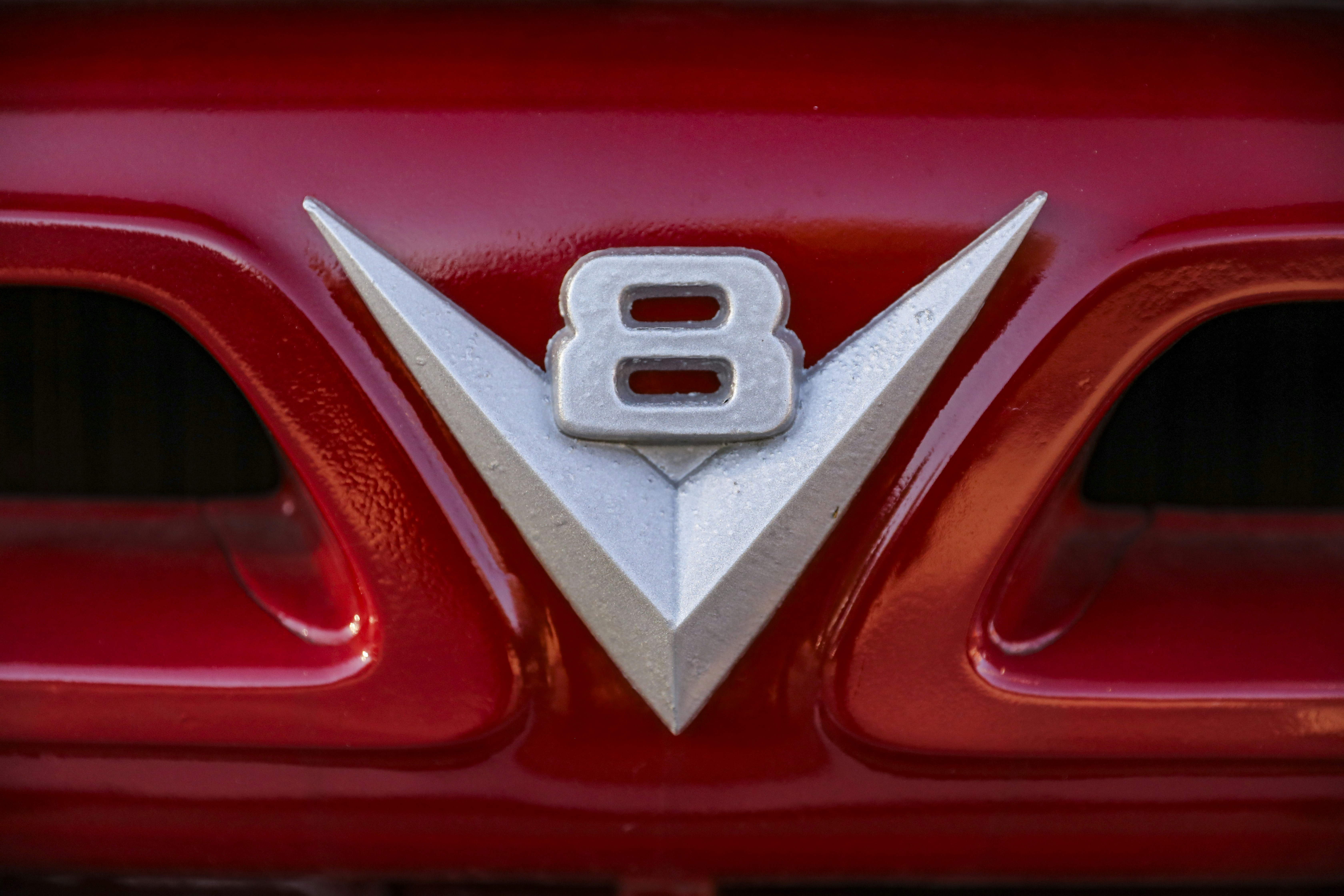 Crimson Hood, Silver V8 Badge: A Close-Up on Power