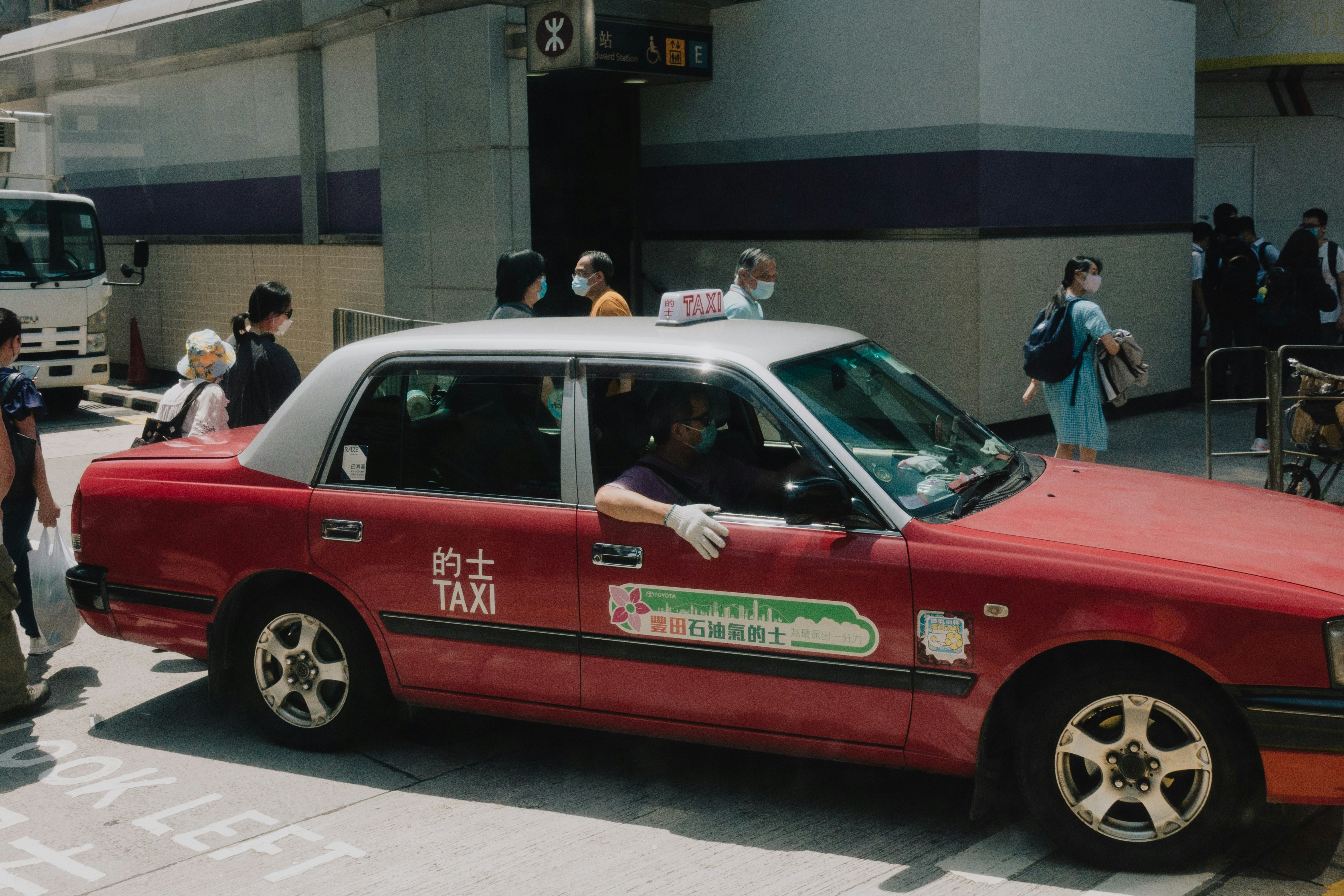 Crimson Taxi at the Curb: A Slice of Busy Street Life