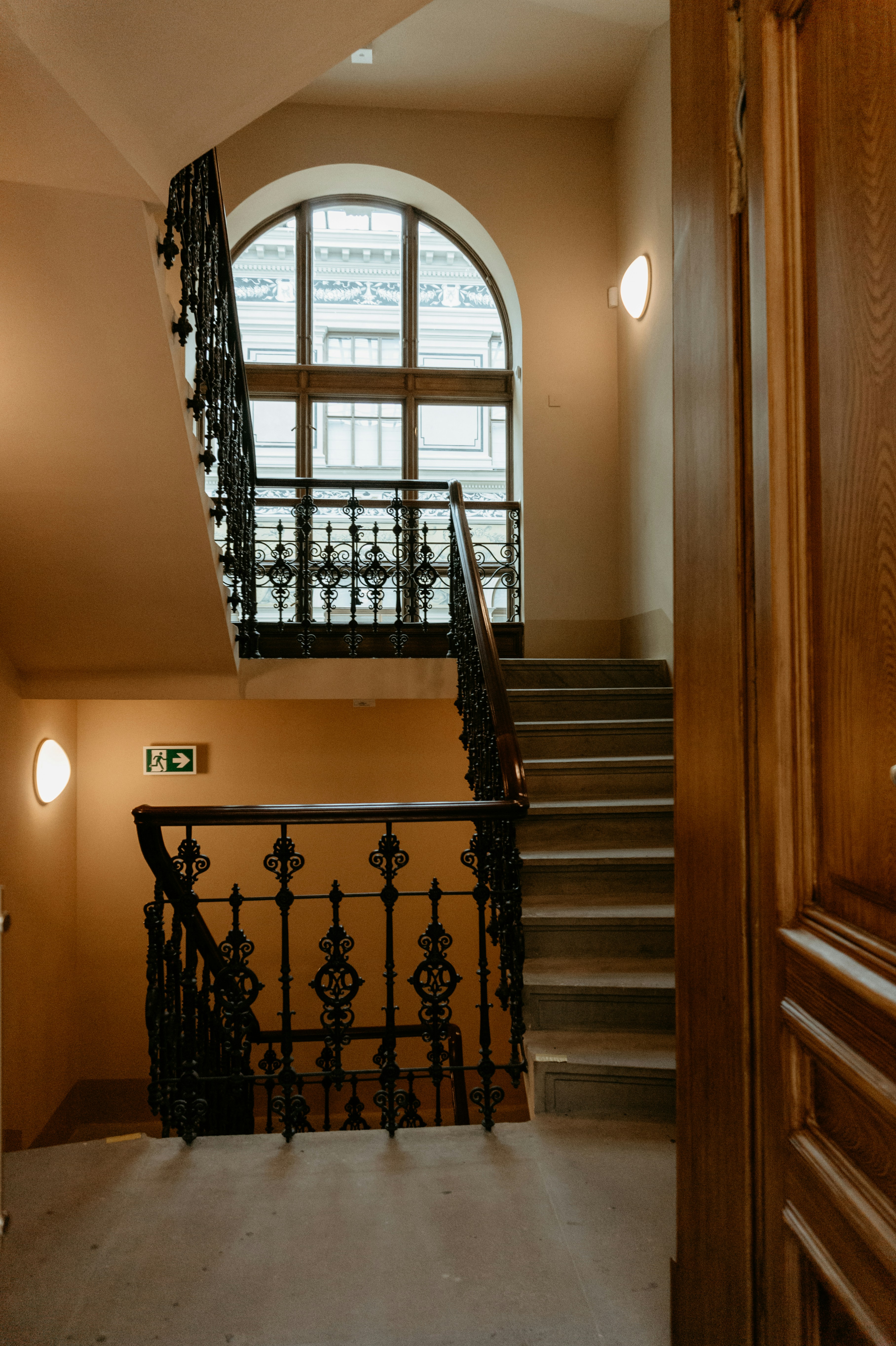 A staircase leading to a large window in a building photo – Free ...