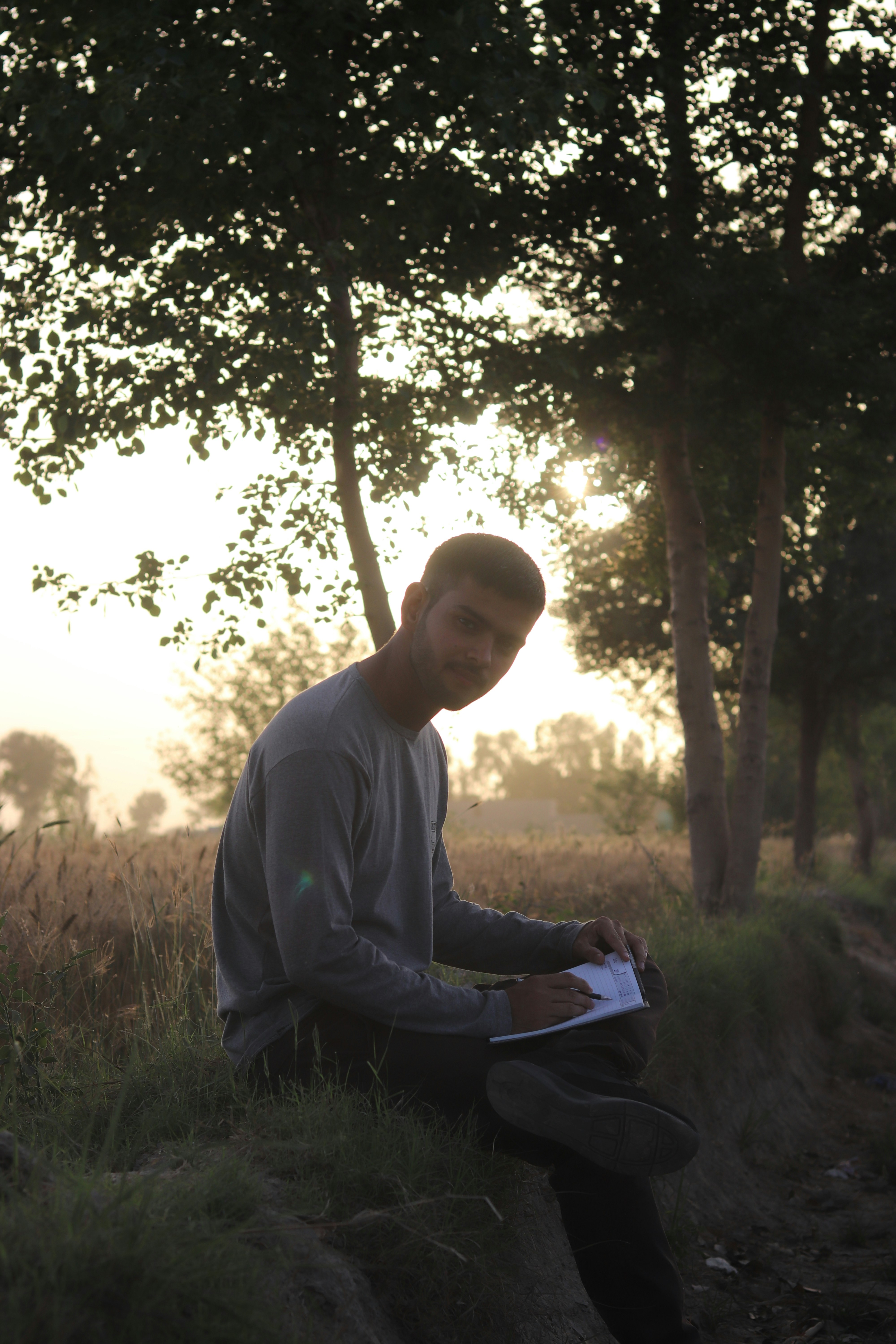 Quiet Scribbles at Dusk: Portrait Amid Golden Backlight