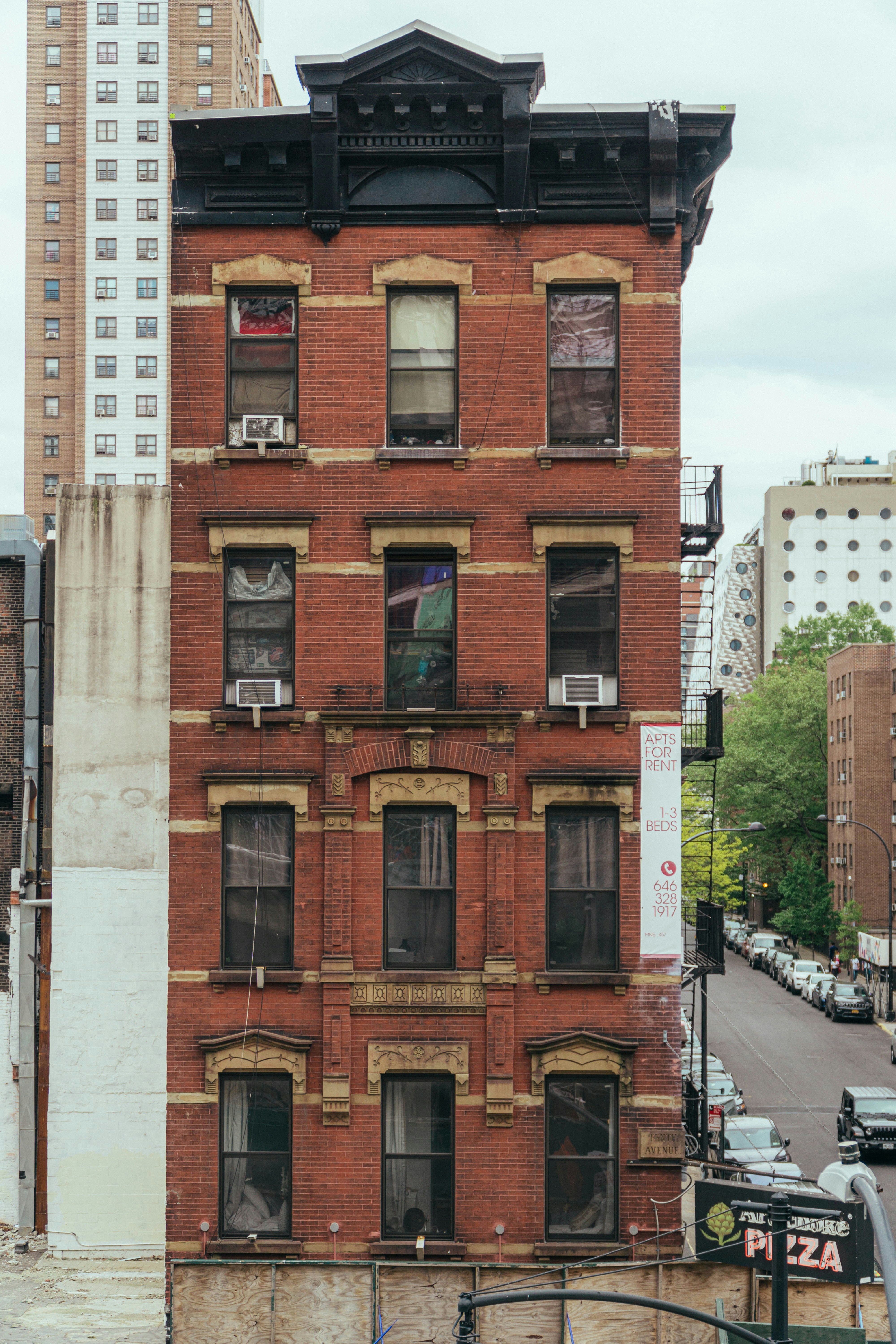 A tall red brick building with lots of windows photo – Free Ny Image on ...