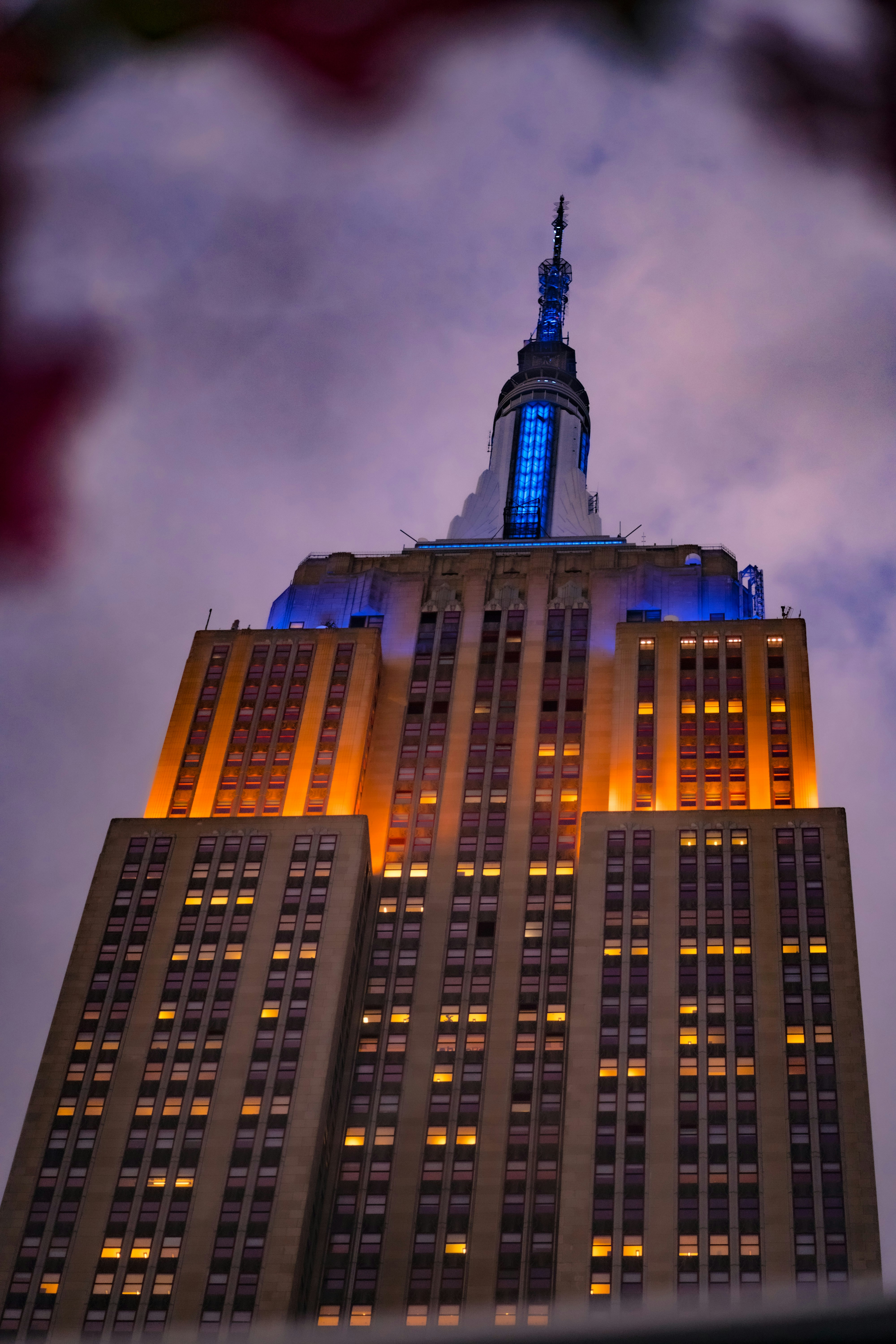 Blue Spire Crown: Nighttime Portrait of a Tower Bathed in Neon Blue and Warm Amber