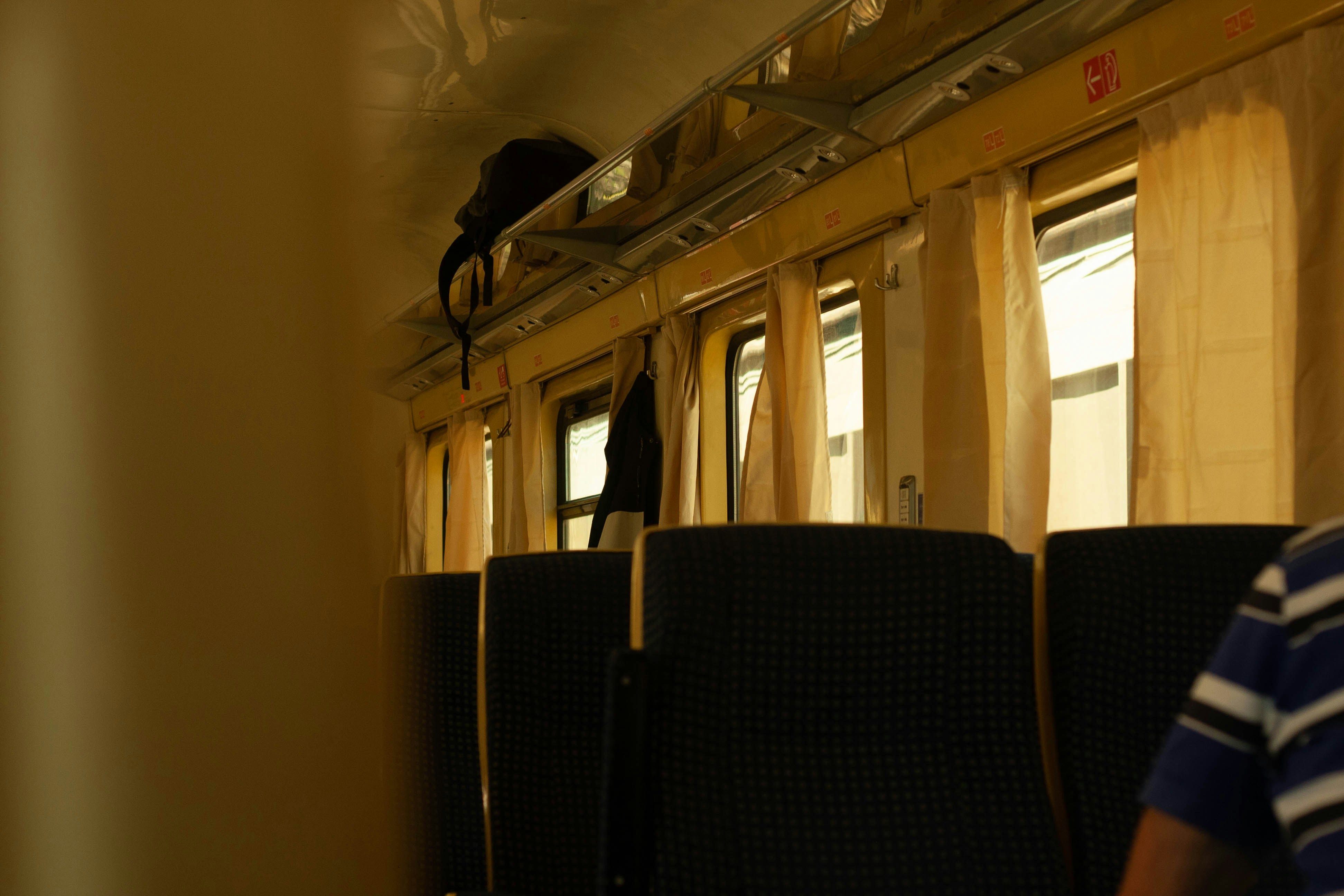 Cinematic lookalike photo while traveling | a man standing on a train looking out the window