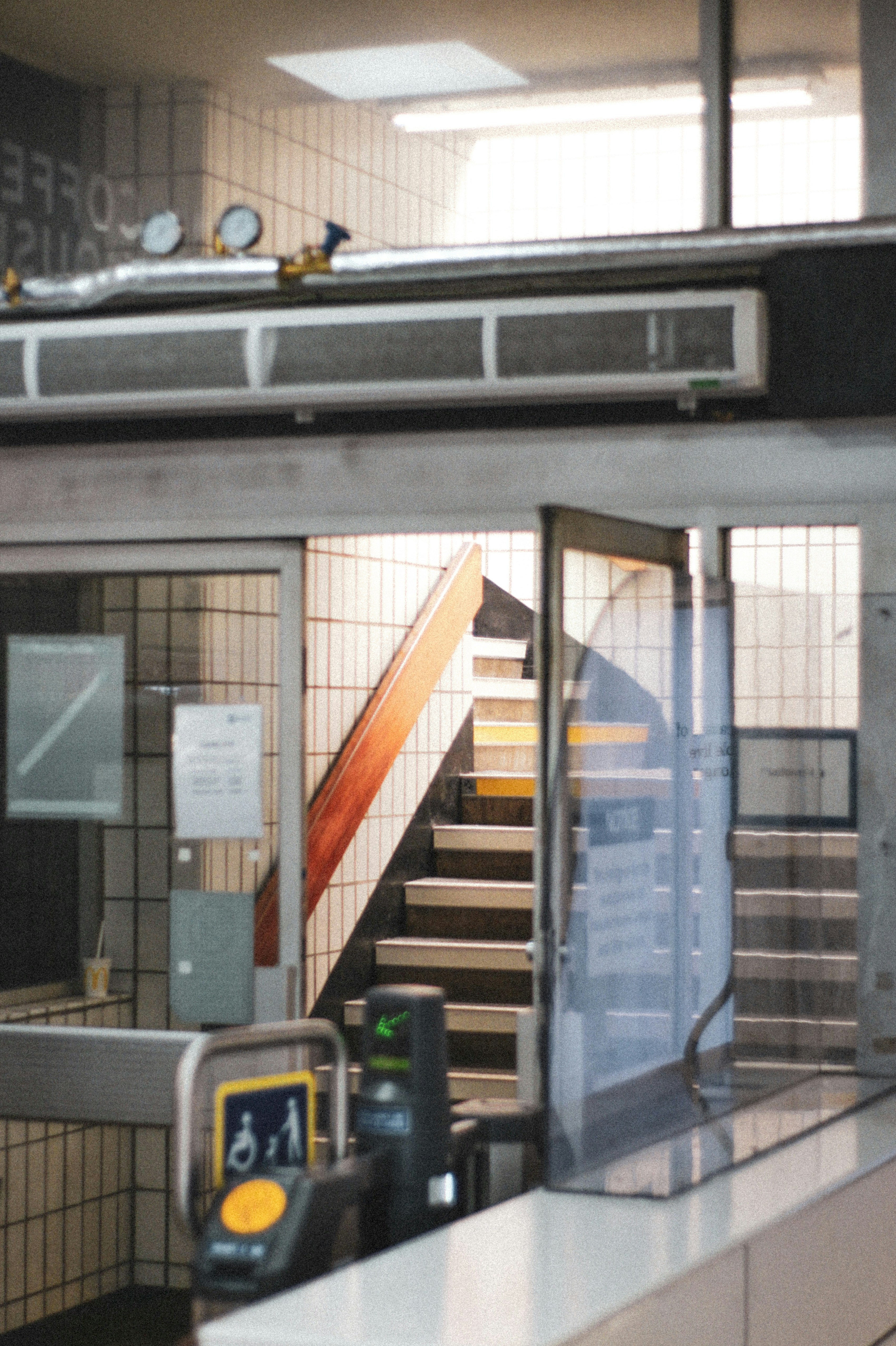 Stairwell Geometry Framed by Glass and Tile
