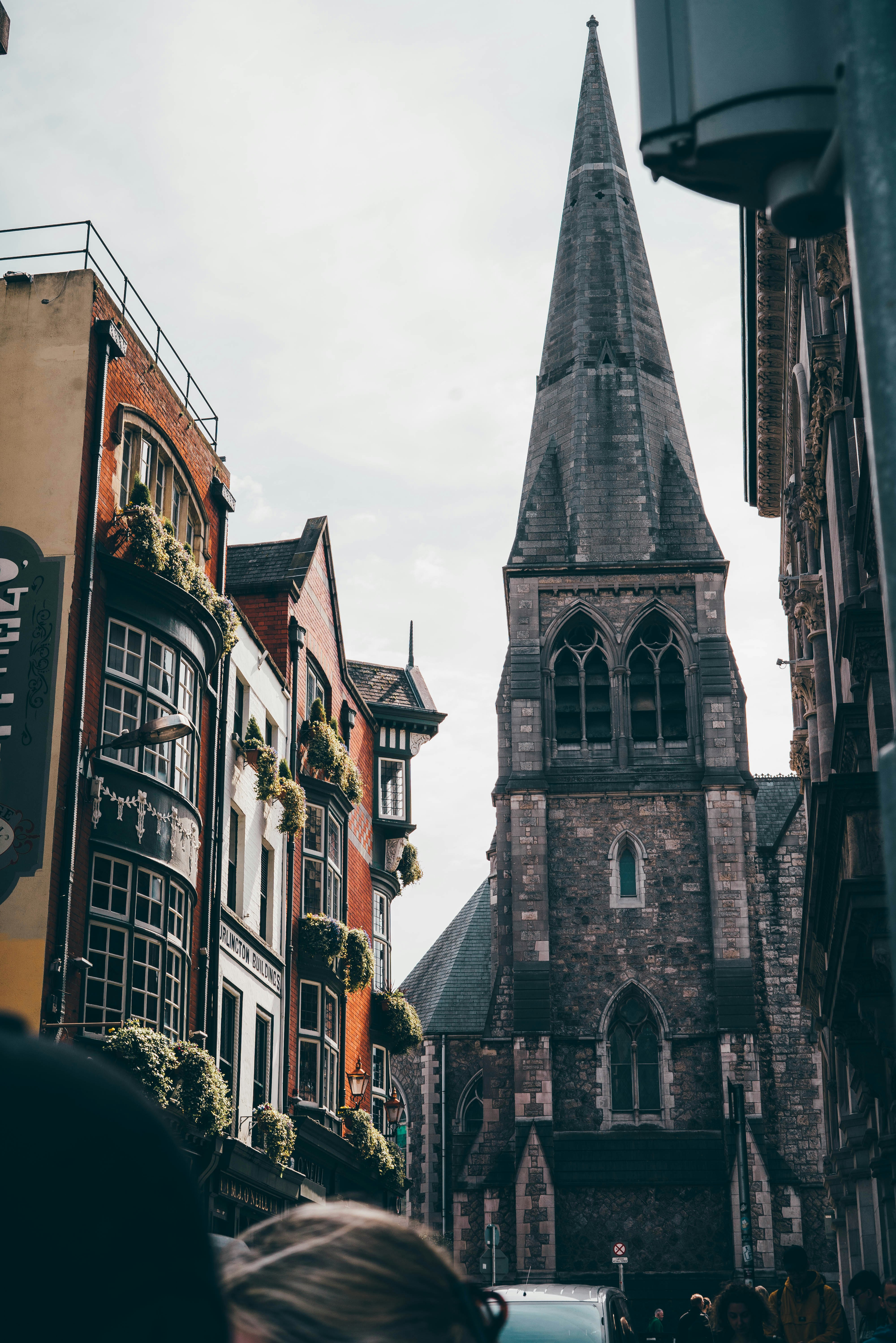 Stark Gothic Spire Between Colorful Facades