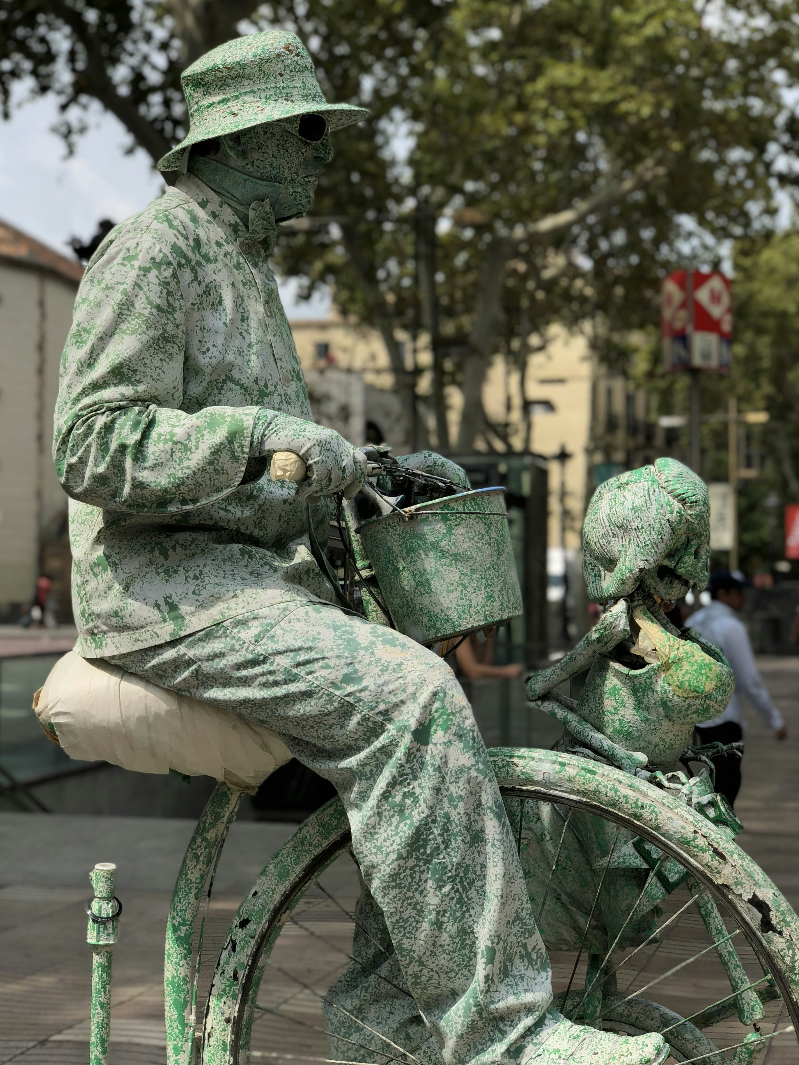 A statue of a man riding a bike with a child photo – Free Art Image on ...