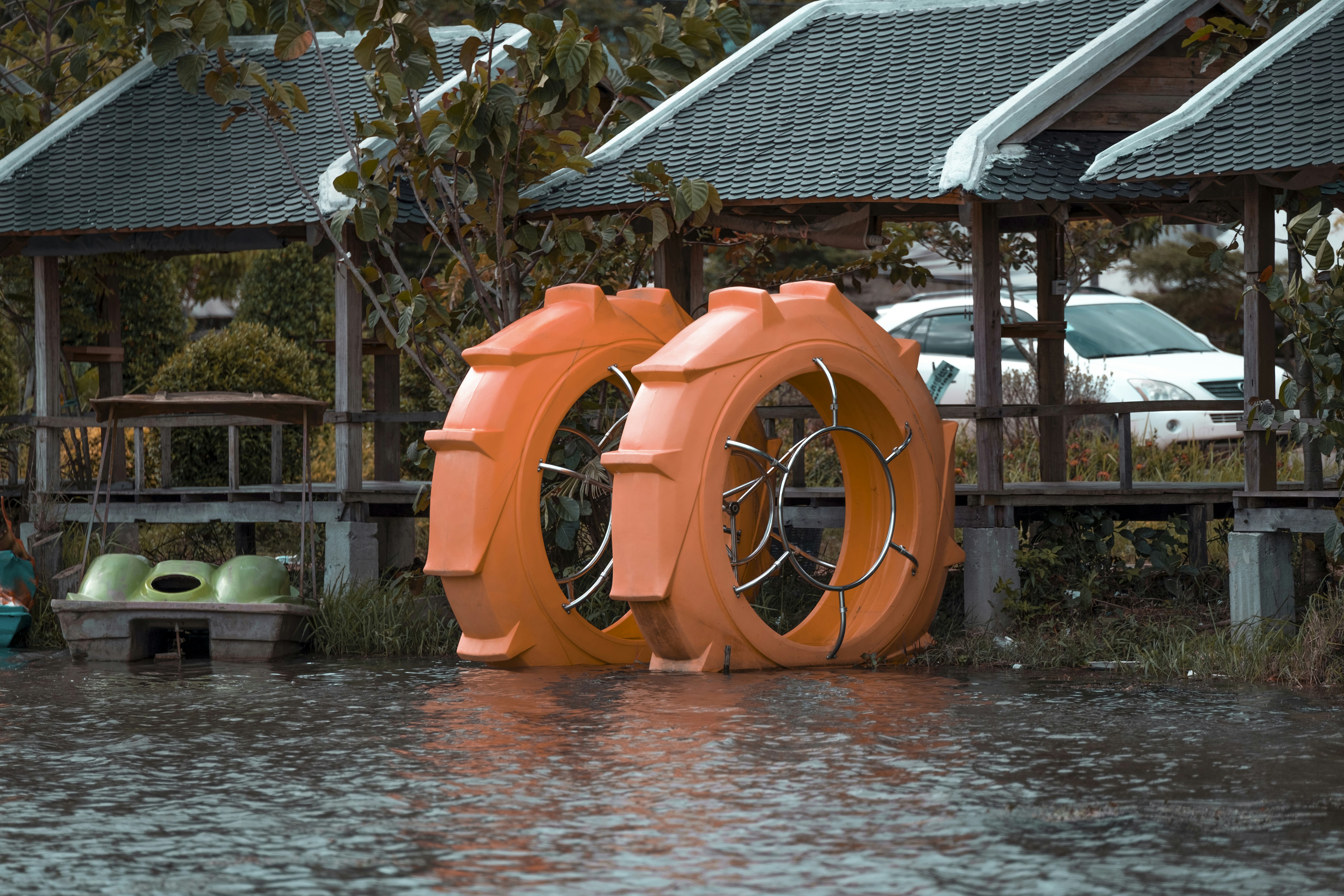 Giant Orange Lifebuoys Stand Guard in a Flooded Courtyard