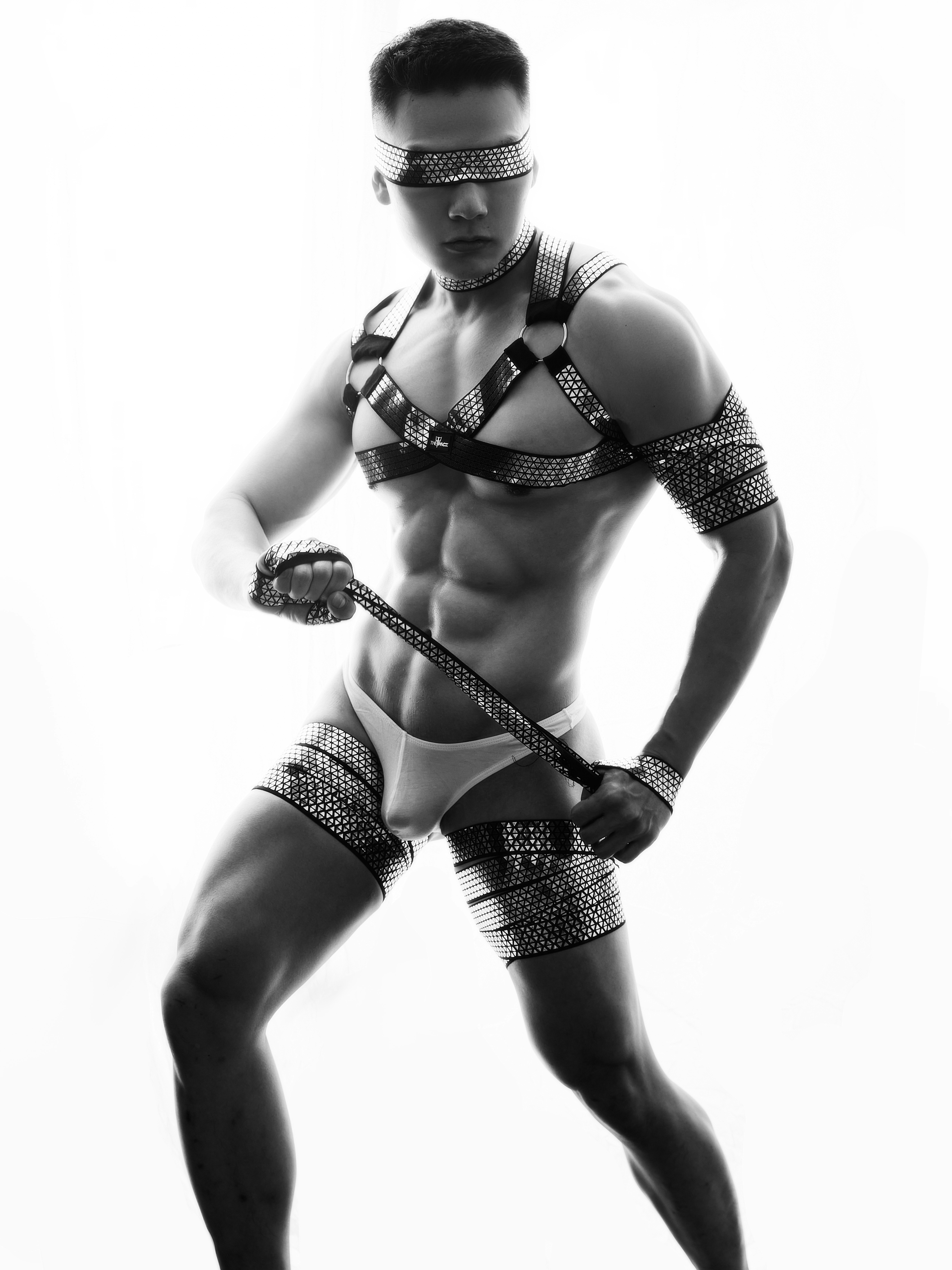 Strapped in Strength: A Pose of Metallic Straps and Focused Gaze