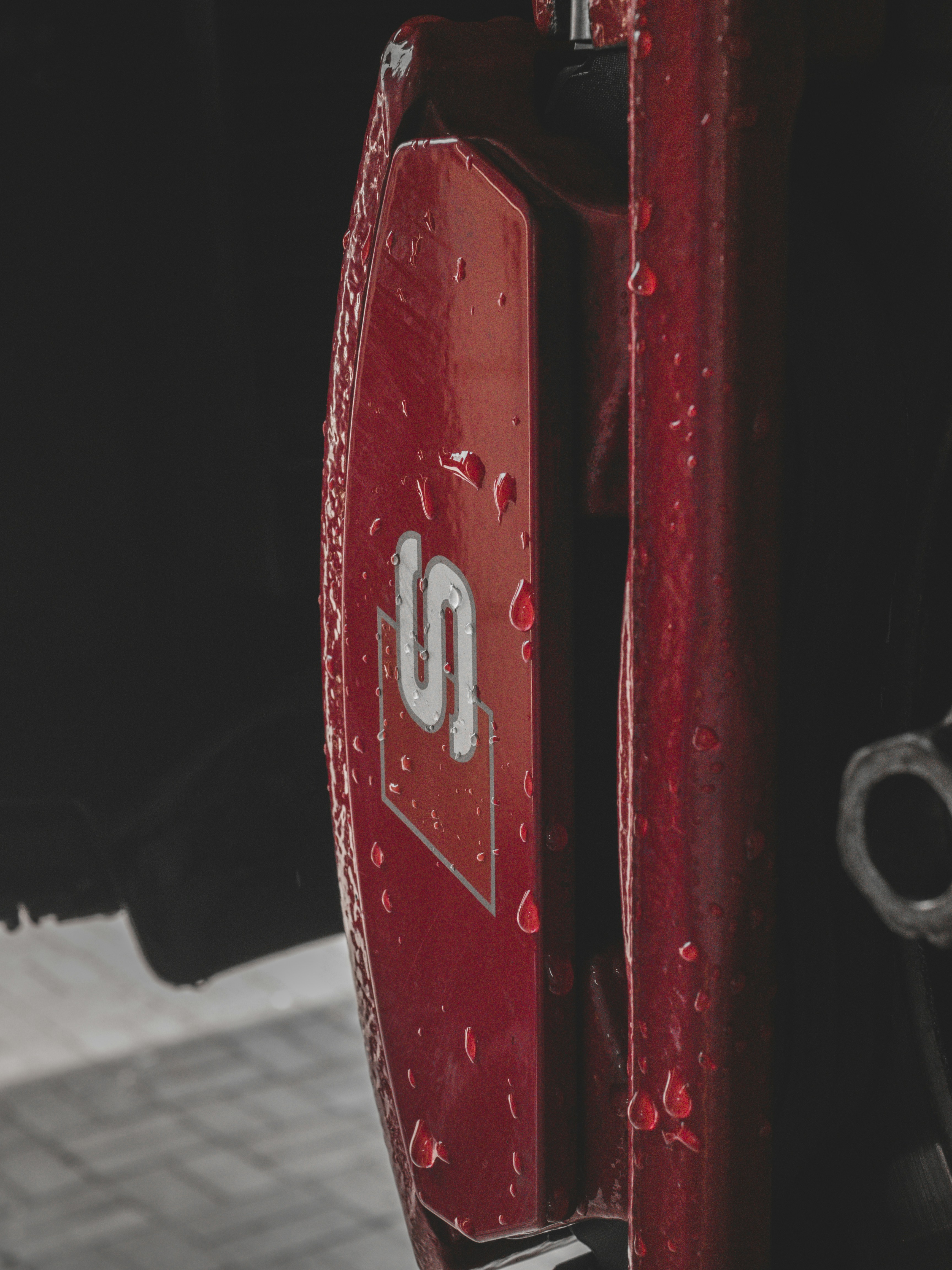 A close up of a red object with water droplets on it photo – Free Brown ...