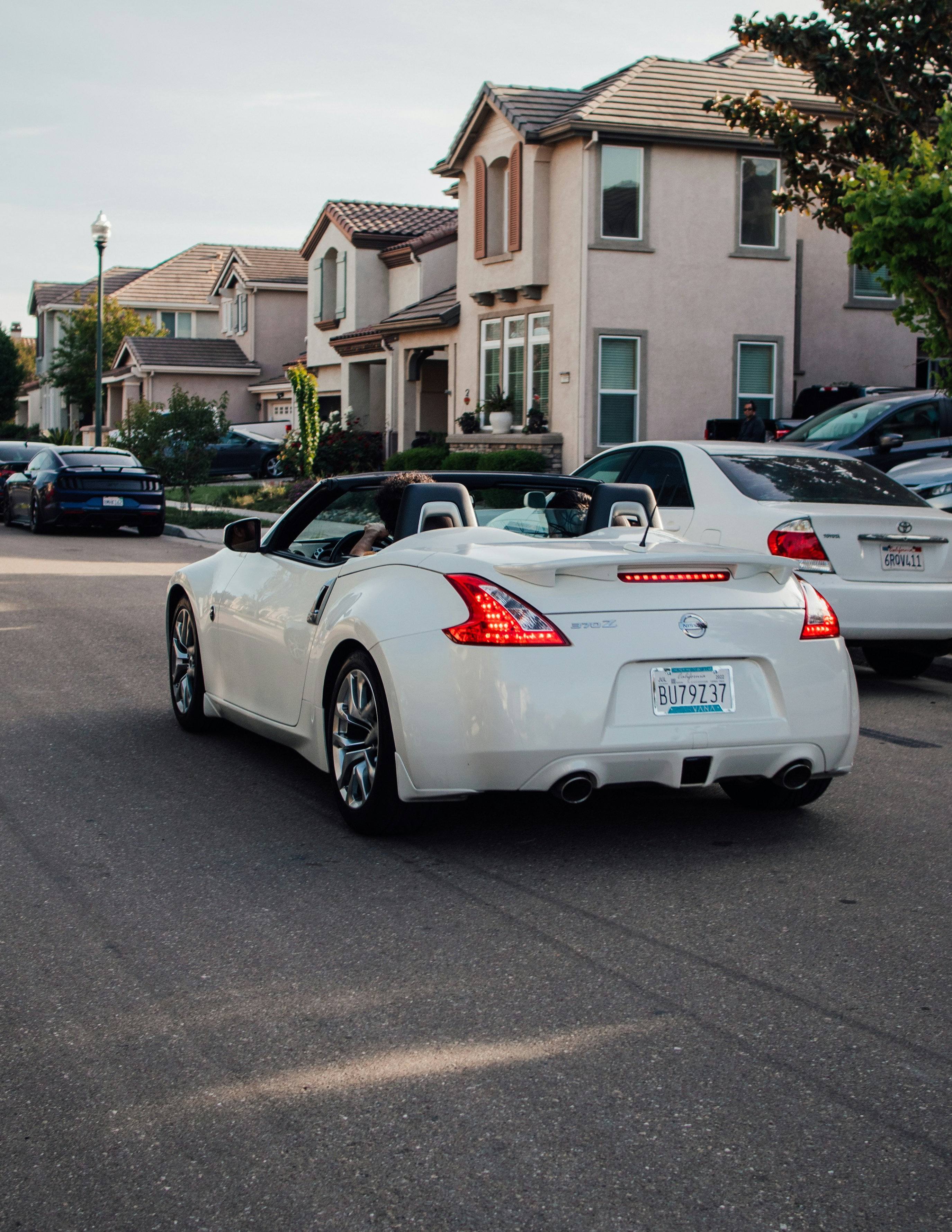 Sunlit Suburban Convertible: White Roadster at the End of the Cul-de-Sac
