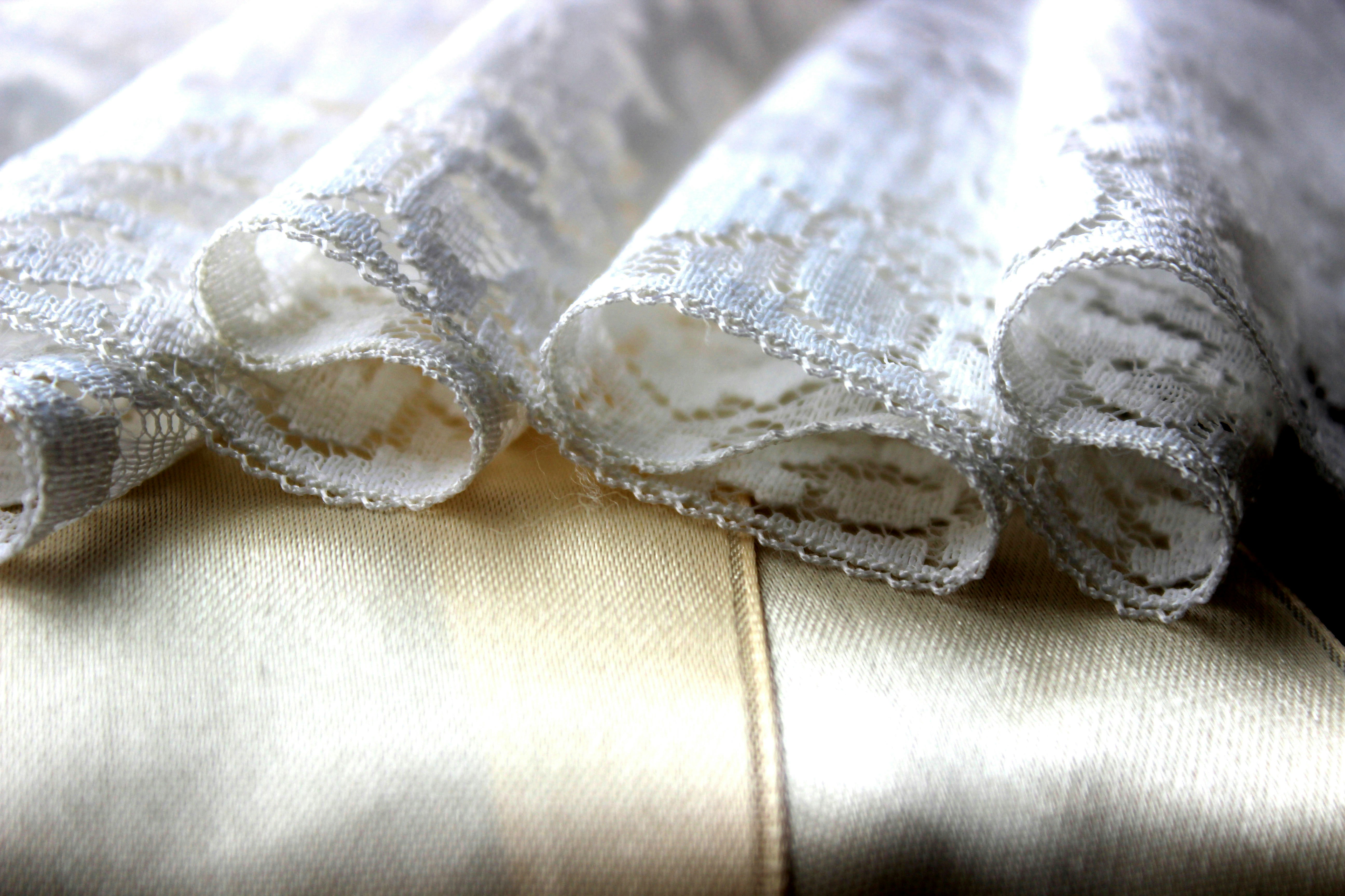 A close up of a bed with a white comforter photo – Free Yellow Image on ...