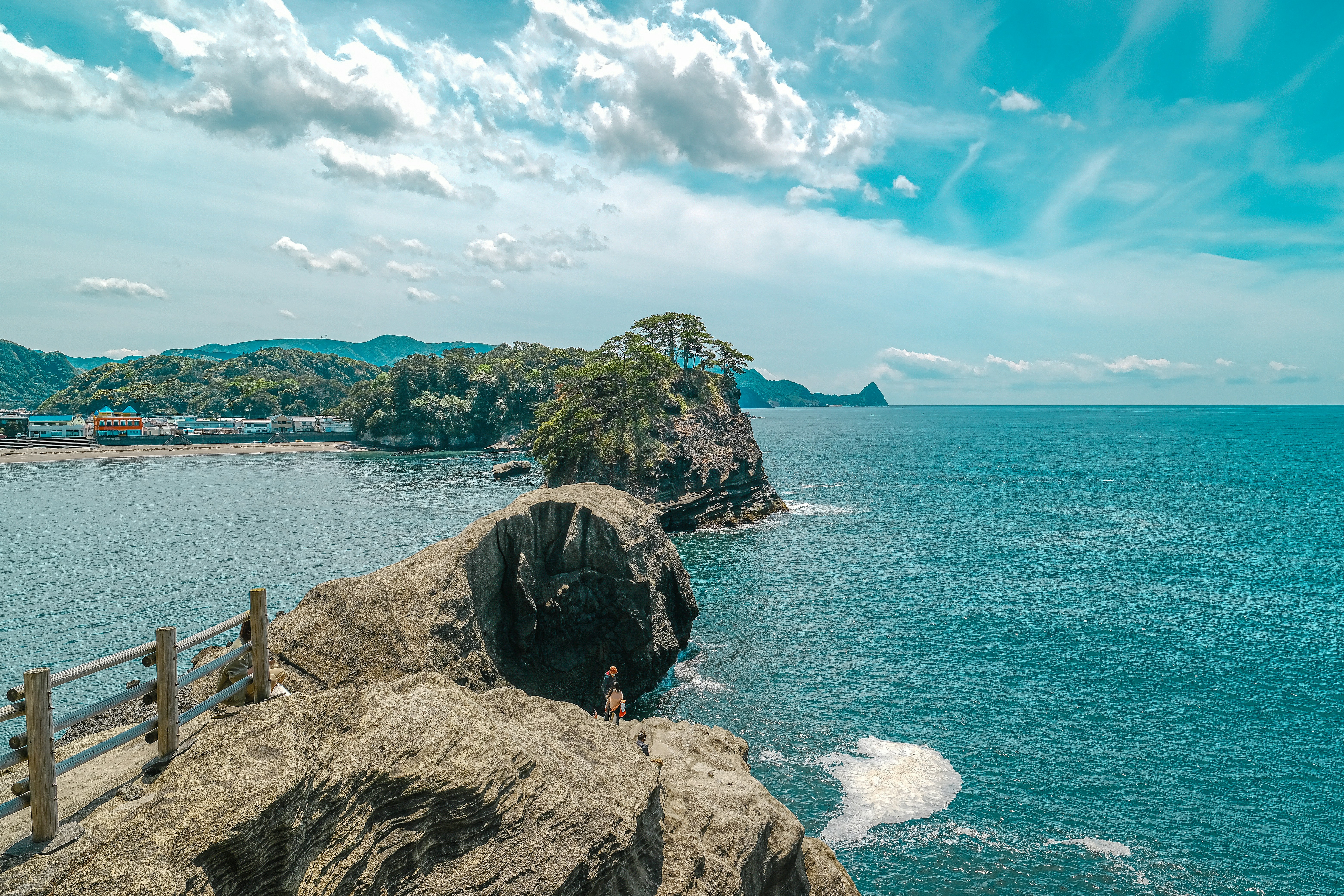 Sea-Arch Promontory: A Lone Figure at the Edge of the Blue Expanse