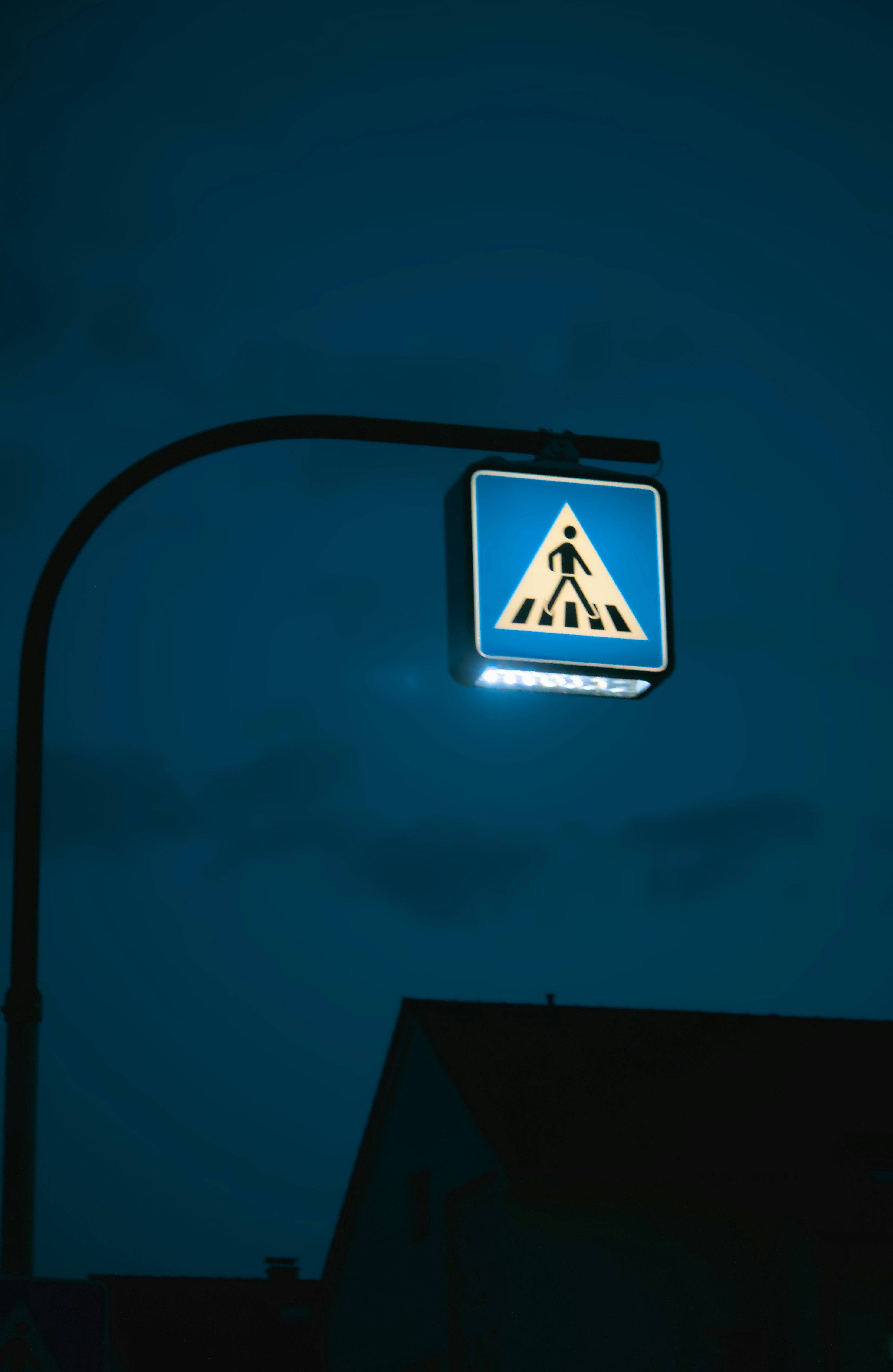 A traffic light with a street sign hanging off of it's side photo ...