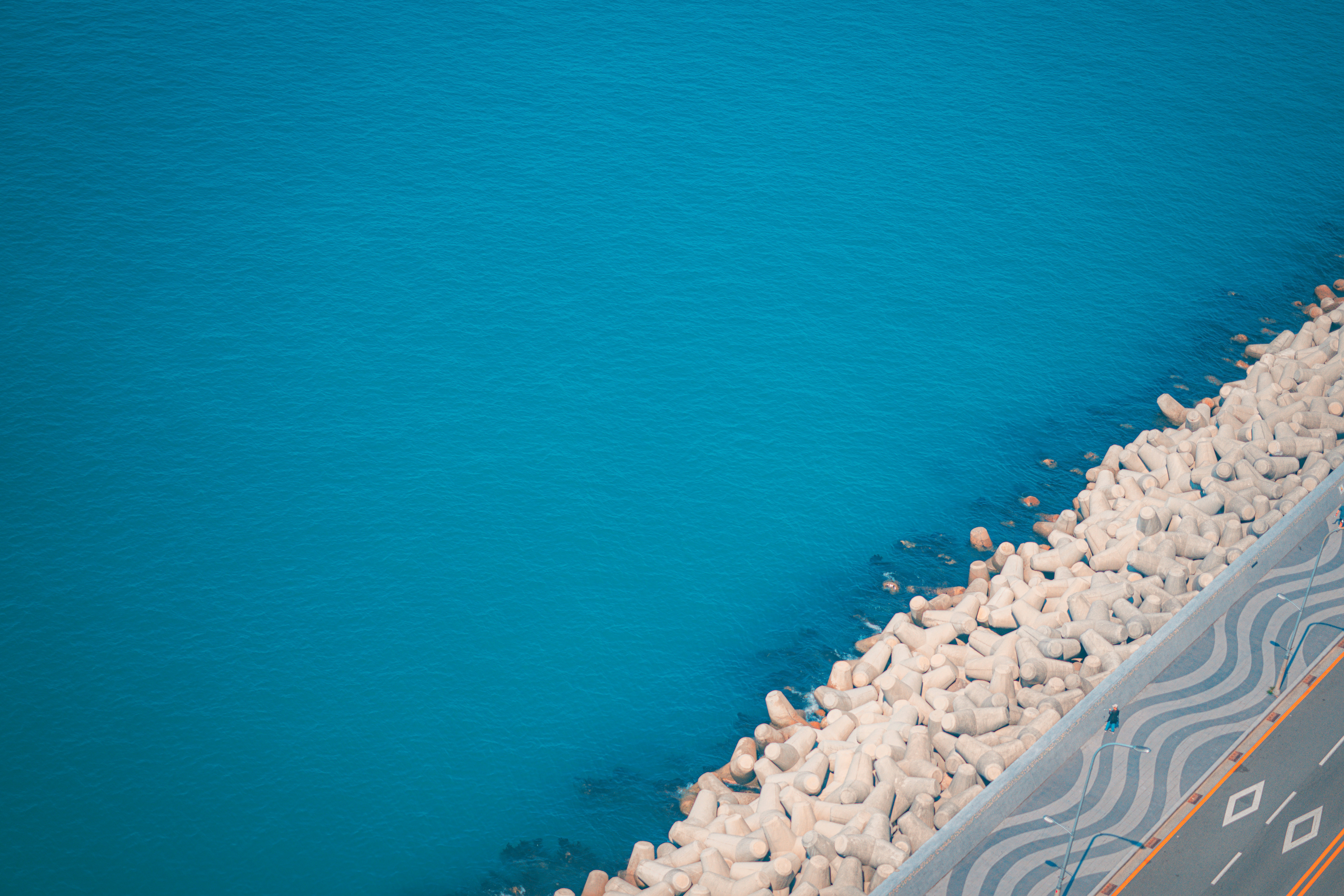 Azure Shoreline: Tilted Launch of Waves and Promenade