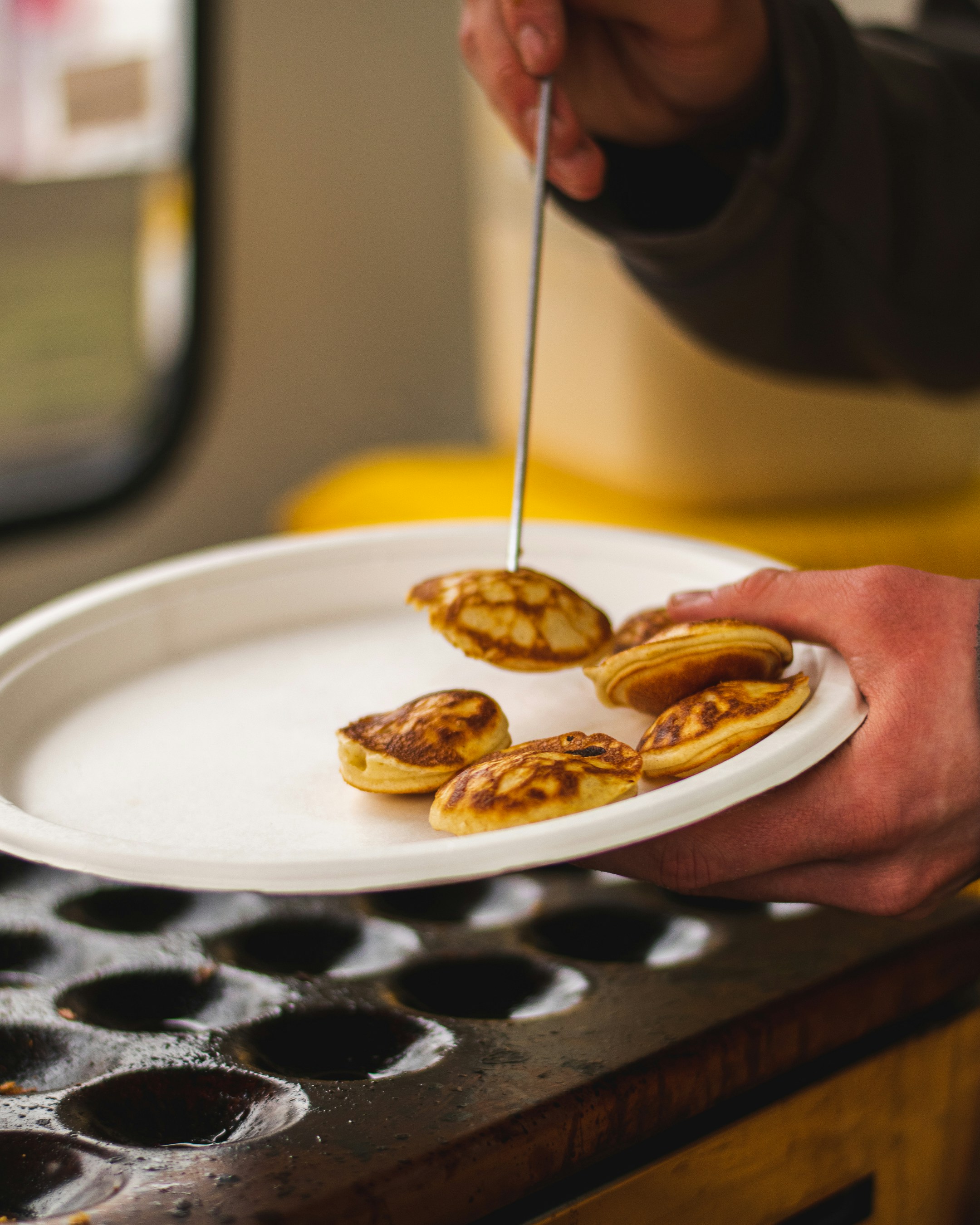 a person holding a plate with some food on it