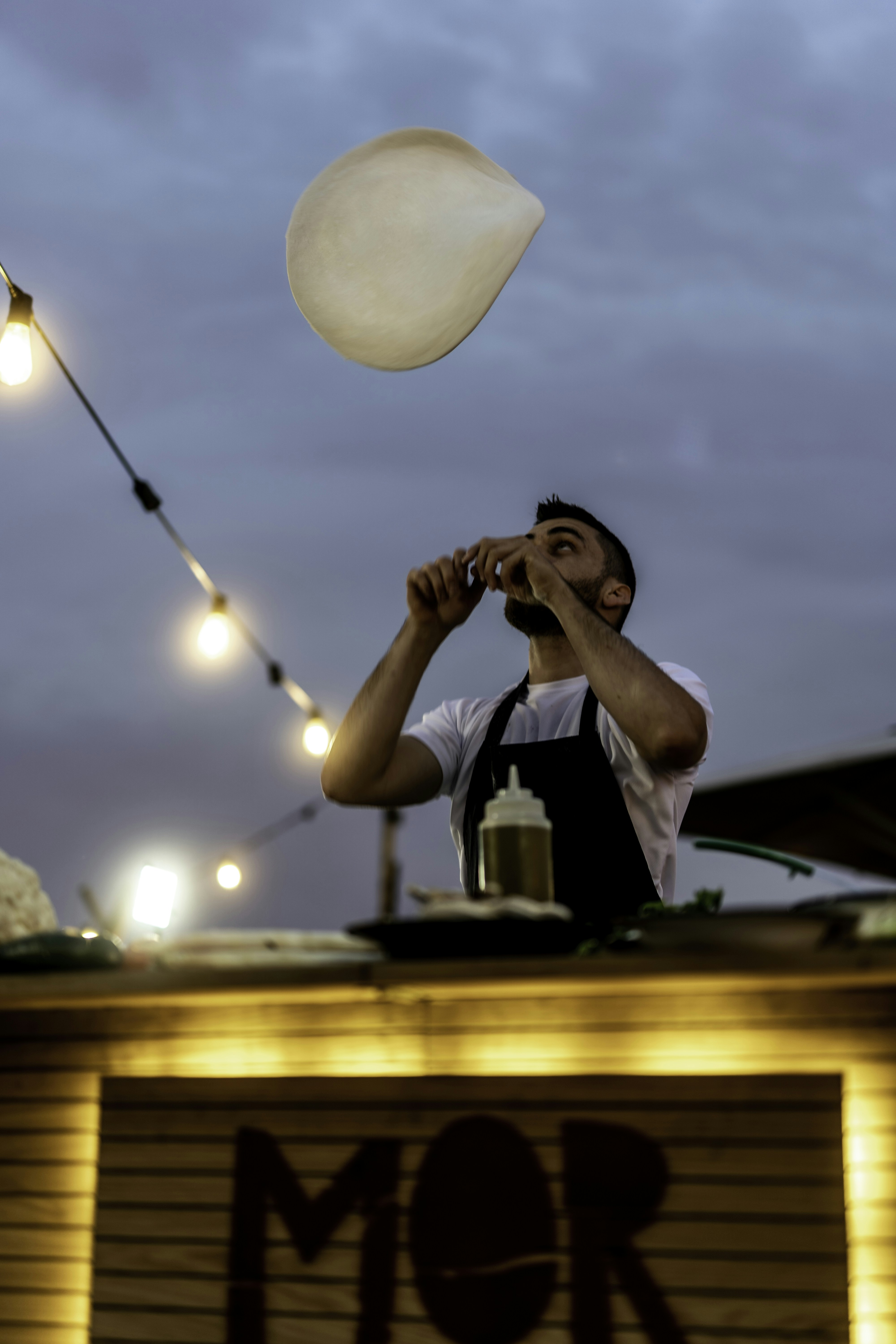 Floating Lantern Toss Over a String-Lit Night Market