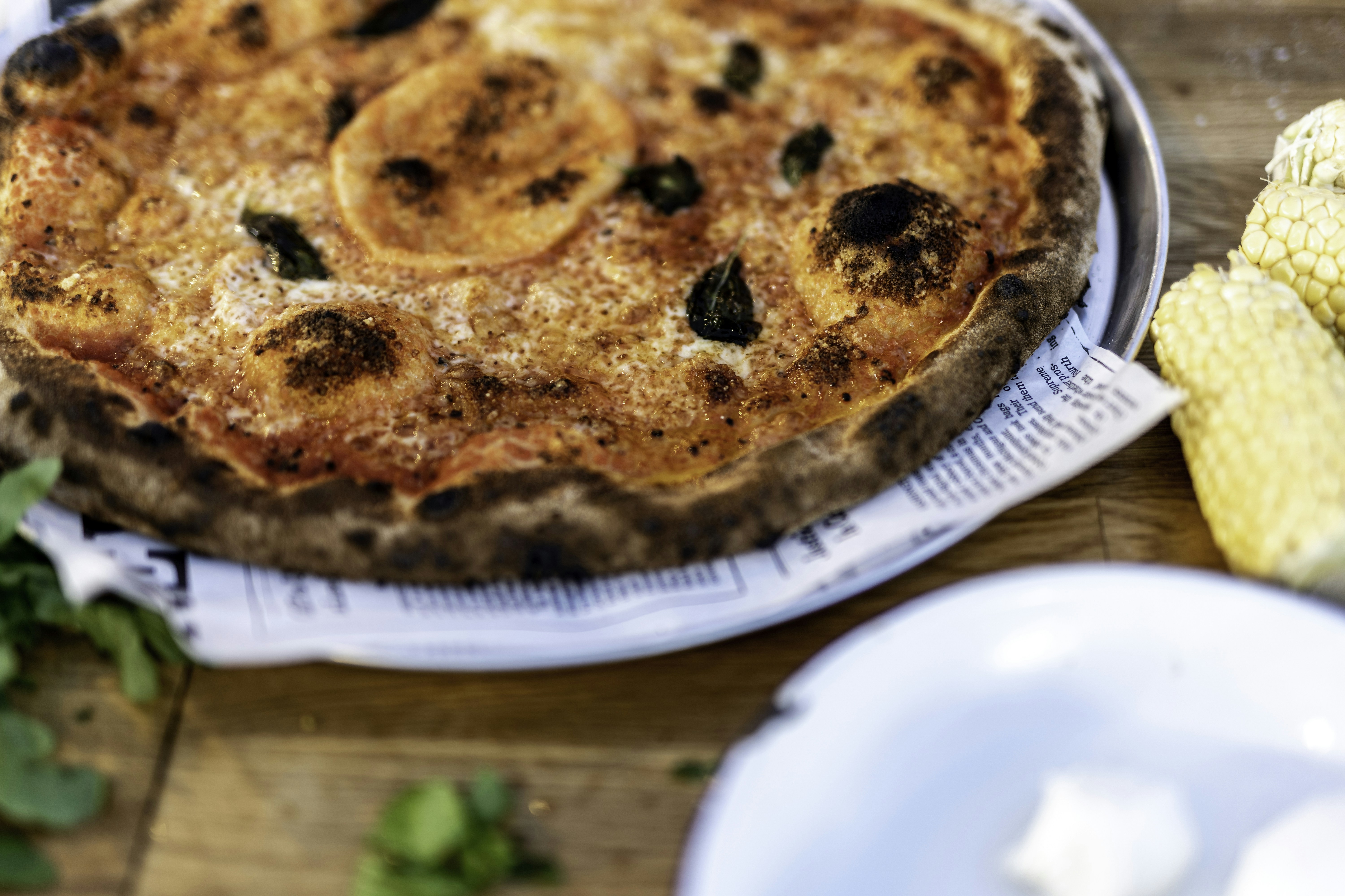 A pizza and corn on the cob on a table photo – Free Cake Image on Unsplash