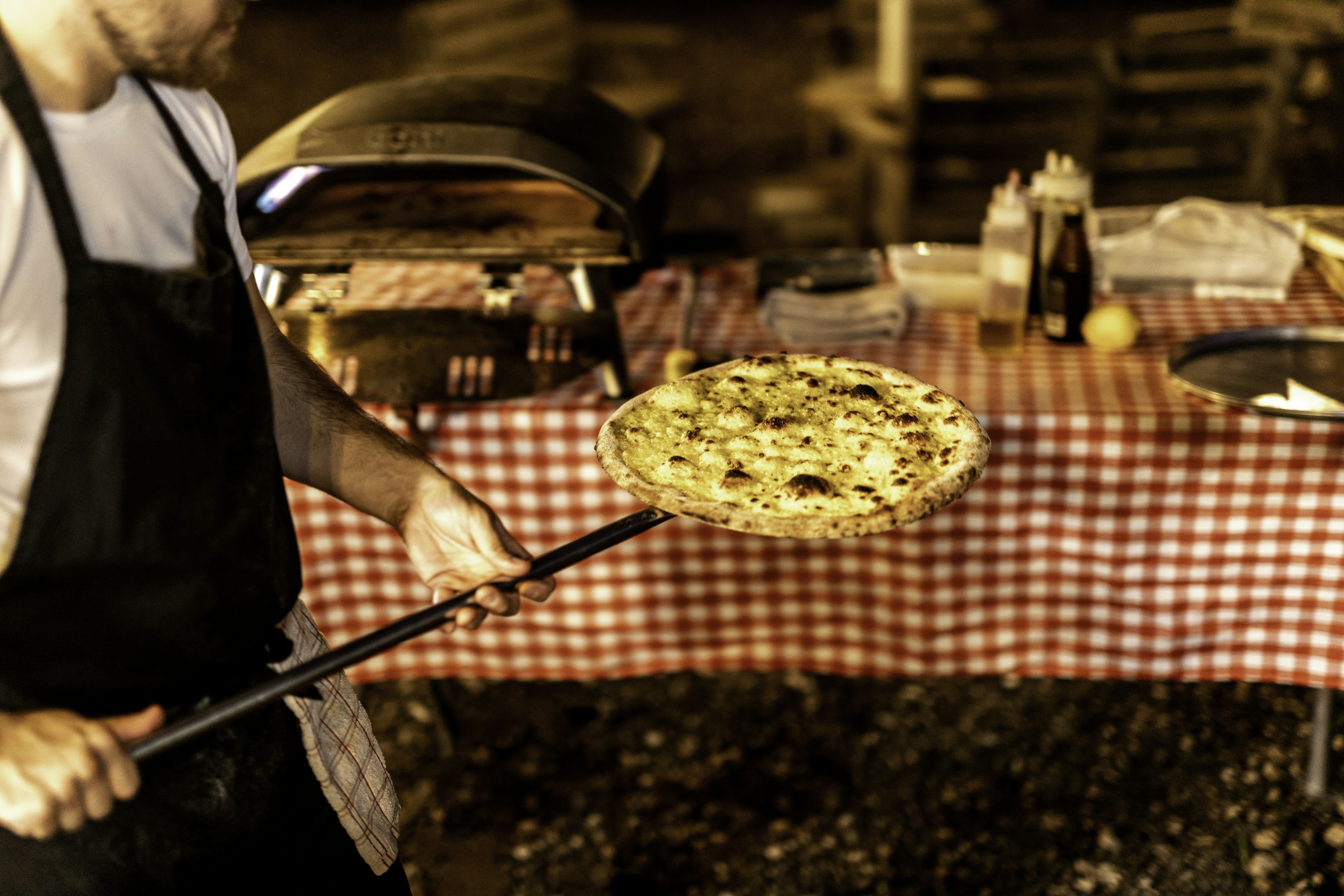 Flight of the Pizza: A Hand Toss at a Rustic Outdoor Stand