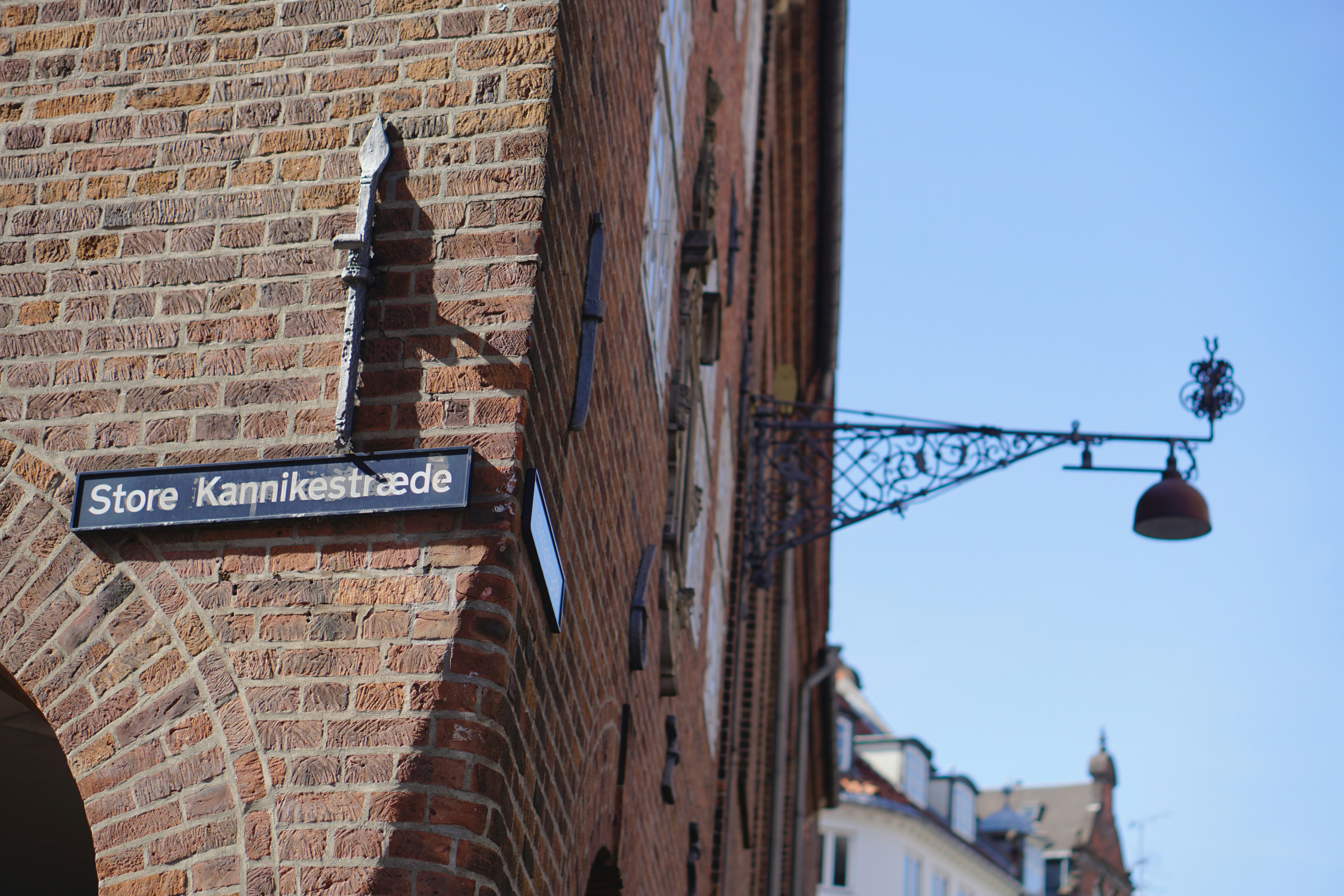 a brick building with a street sign on it