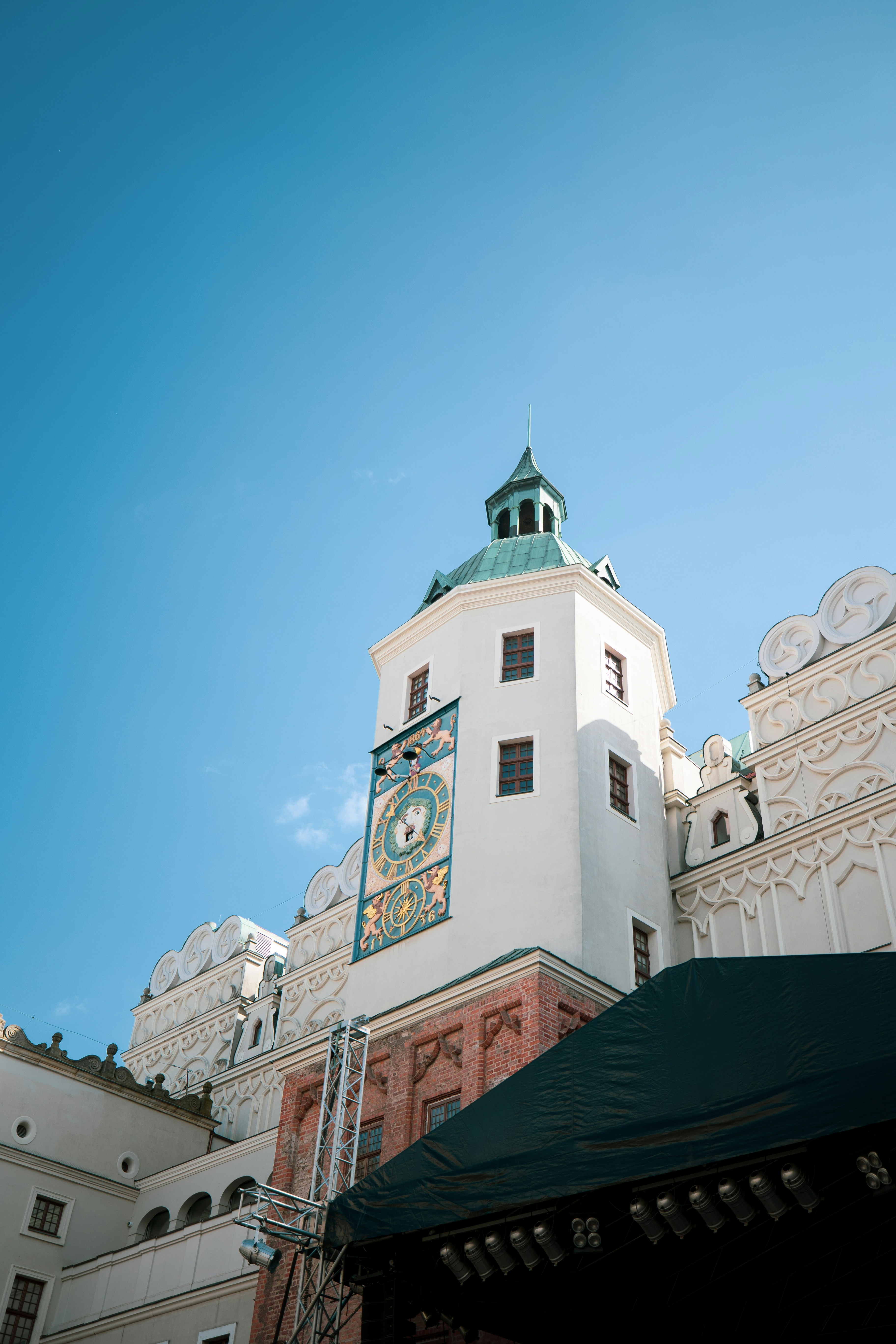 Clock Tower Rising Above White Facades Under Open Sky