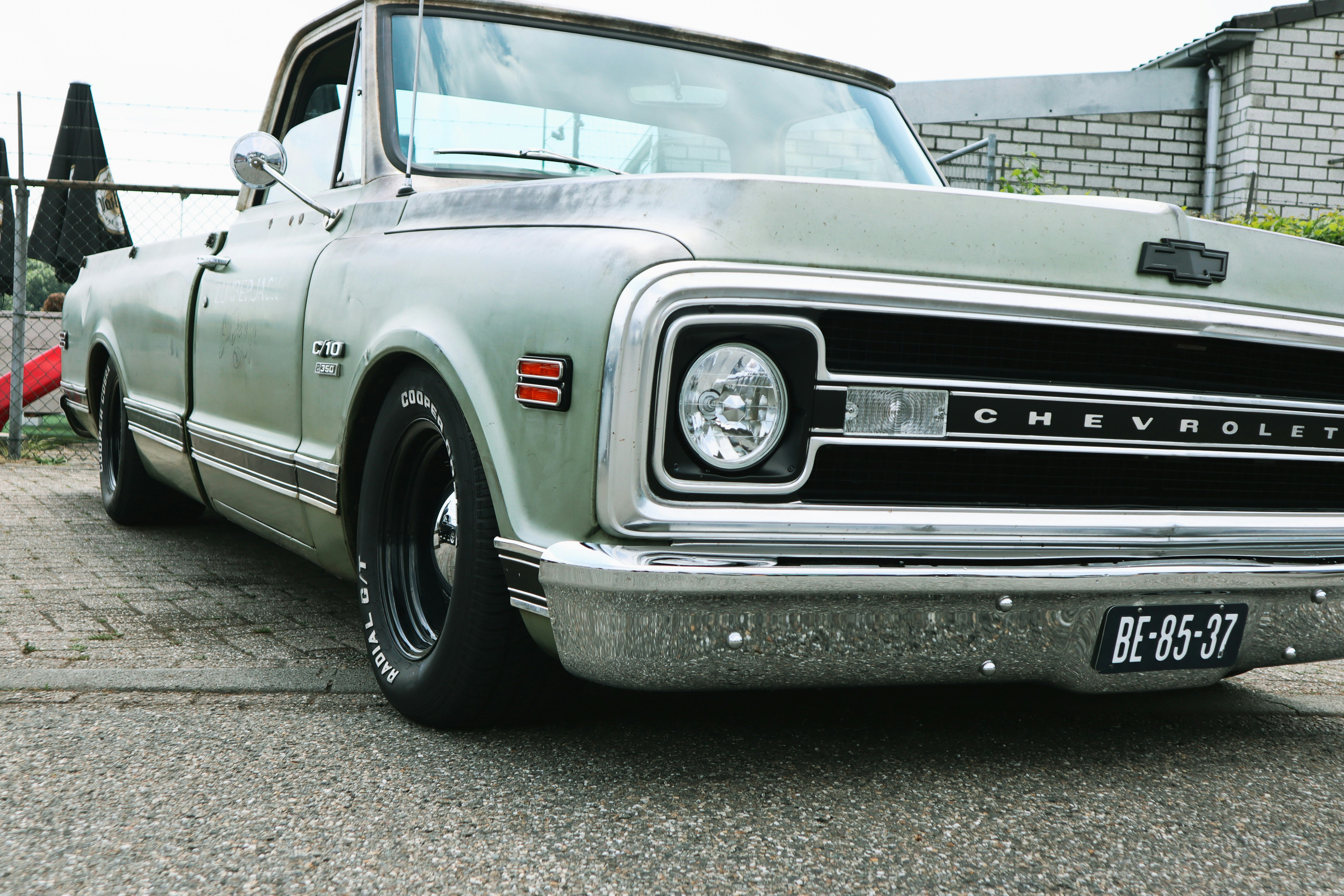 A green chevrolet truck parked in a parking lot photo – Free Grey Image ...