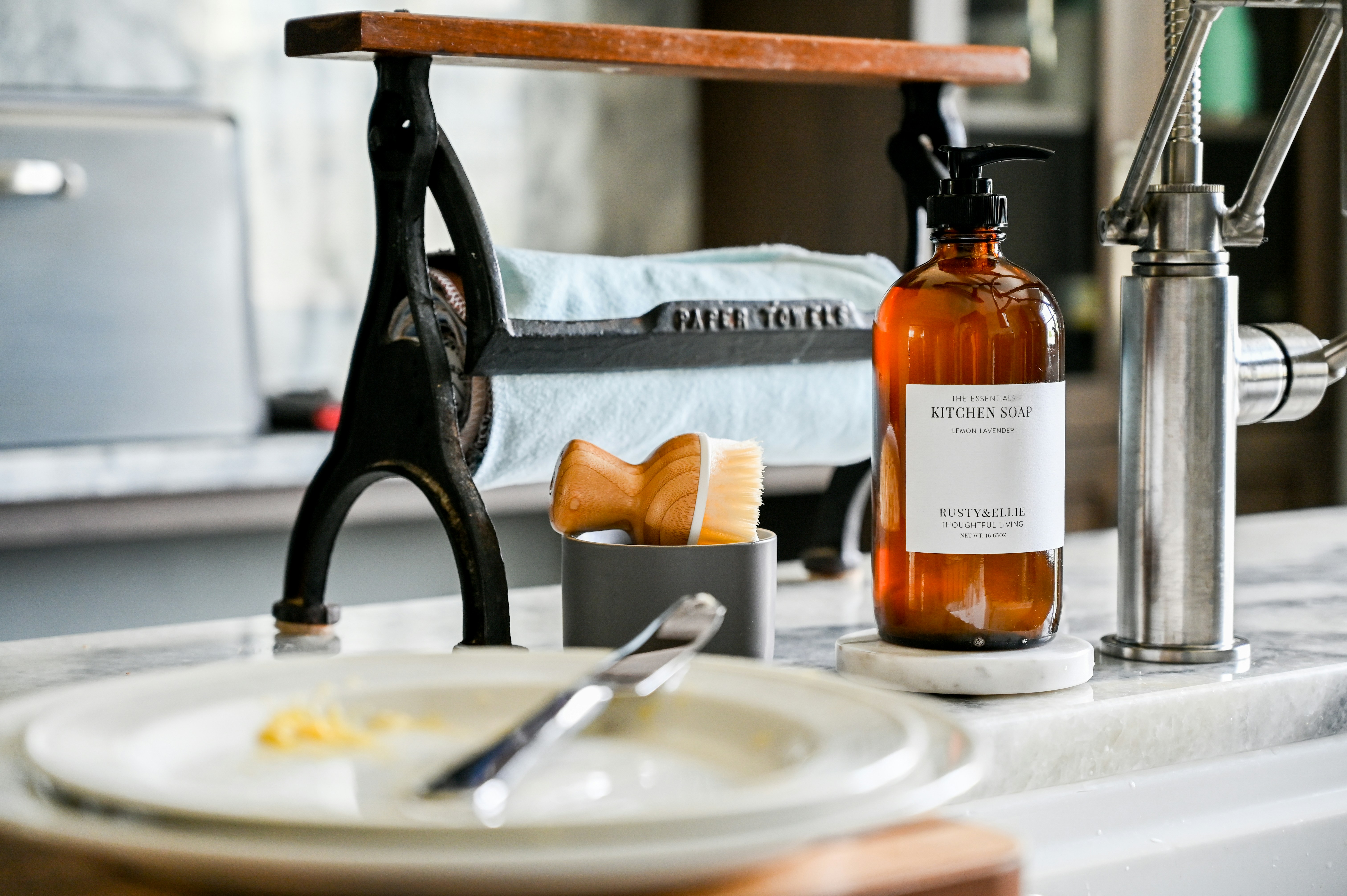 Countertop Ritual: A Bottle, Brush, and Plate in a Quiet Kitchen Scene
