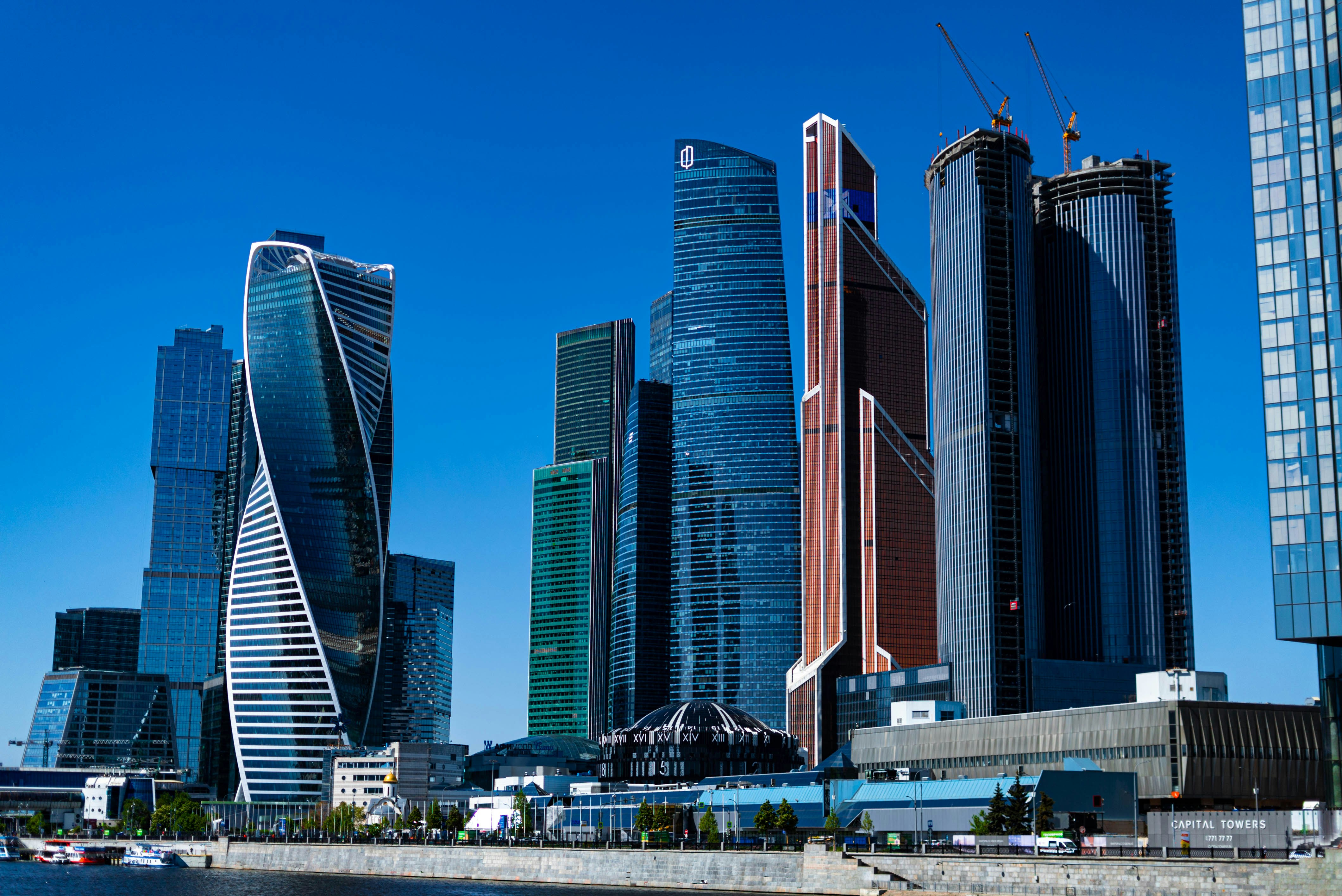 A collection of modern skyscrapers showcasing innovative architectural designs against a clear blue sky.