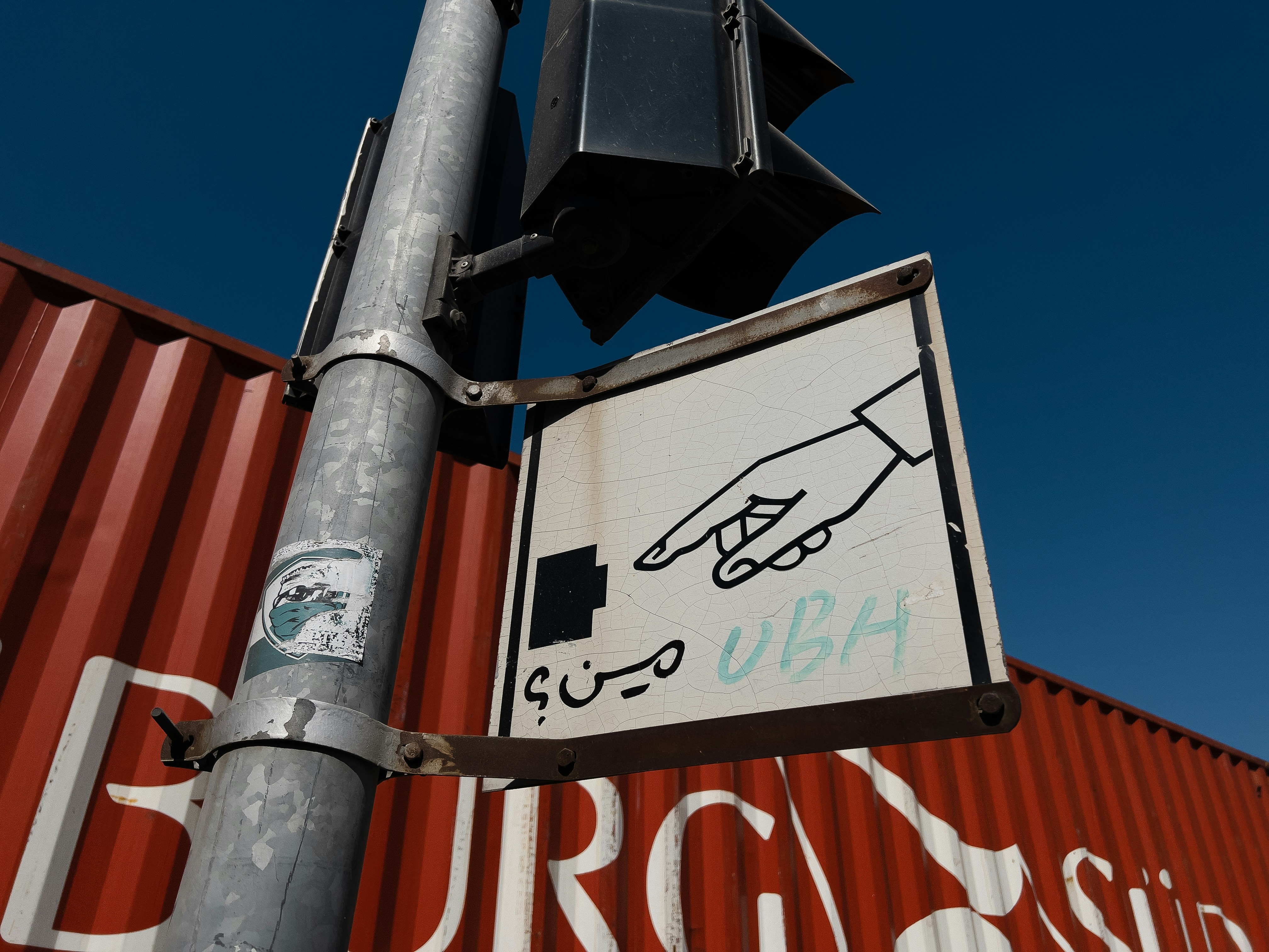 A street sign with a hand drawn on it photo – Free Haifa Image on Unsplash