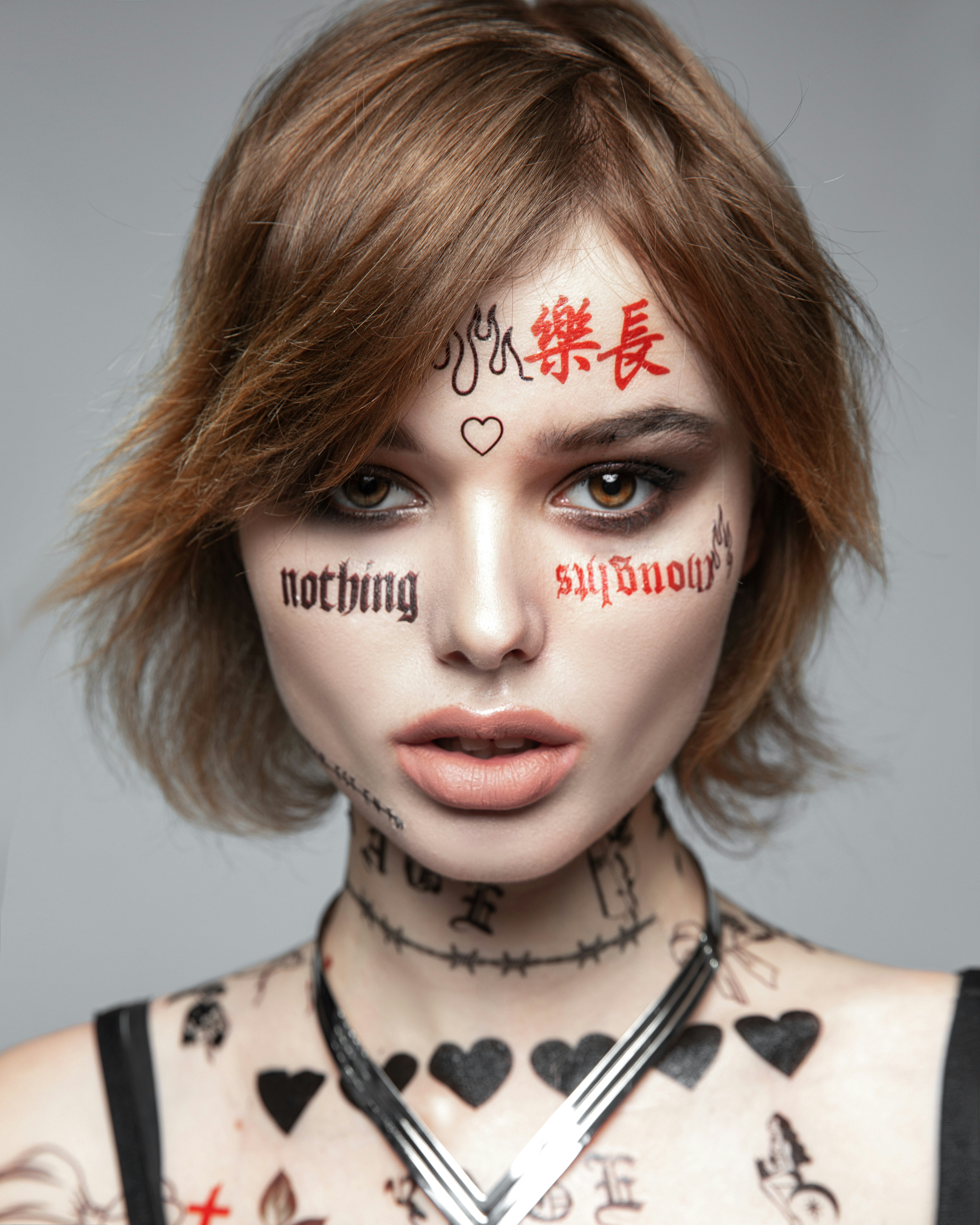 Ink-Stitched Gaze: Studio Portrait of Tattoos, Soft Light, and Metallic Accents