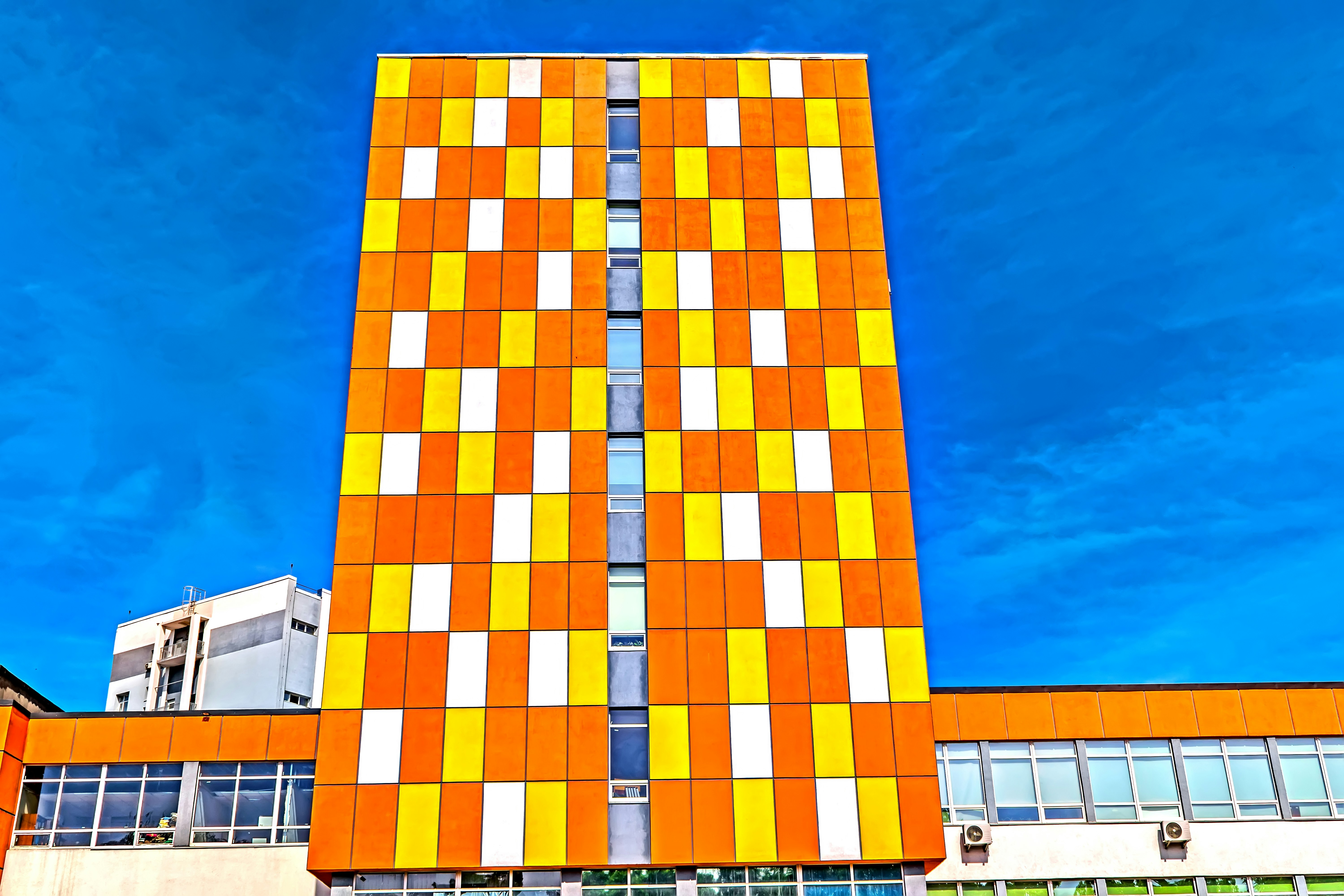 Vertical Mosaic Prism: An Orange-Yellow Facade Reaching for the Sky