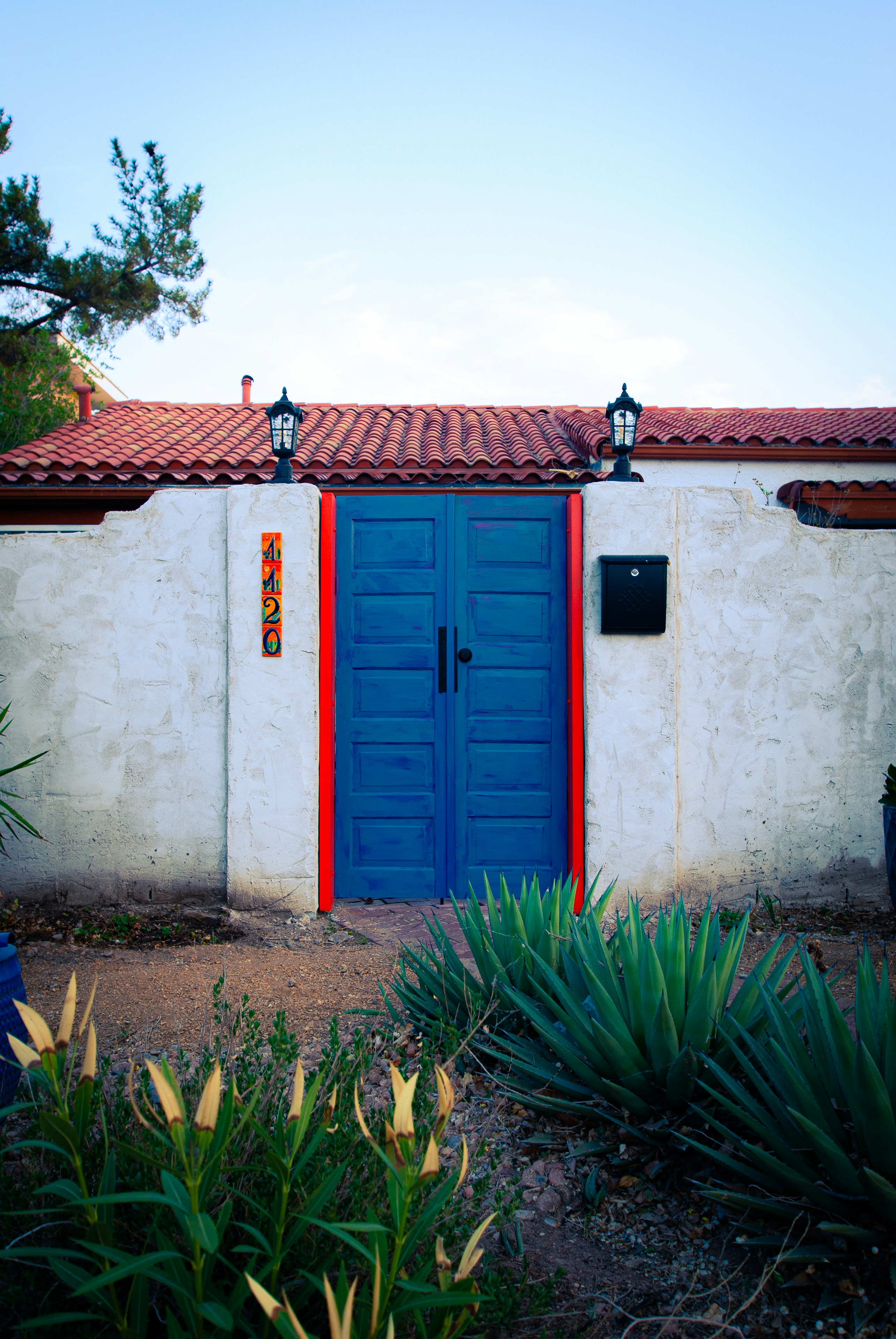 Azure Doorway Framed by White Wall and Coral Trim