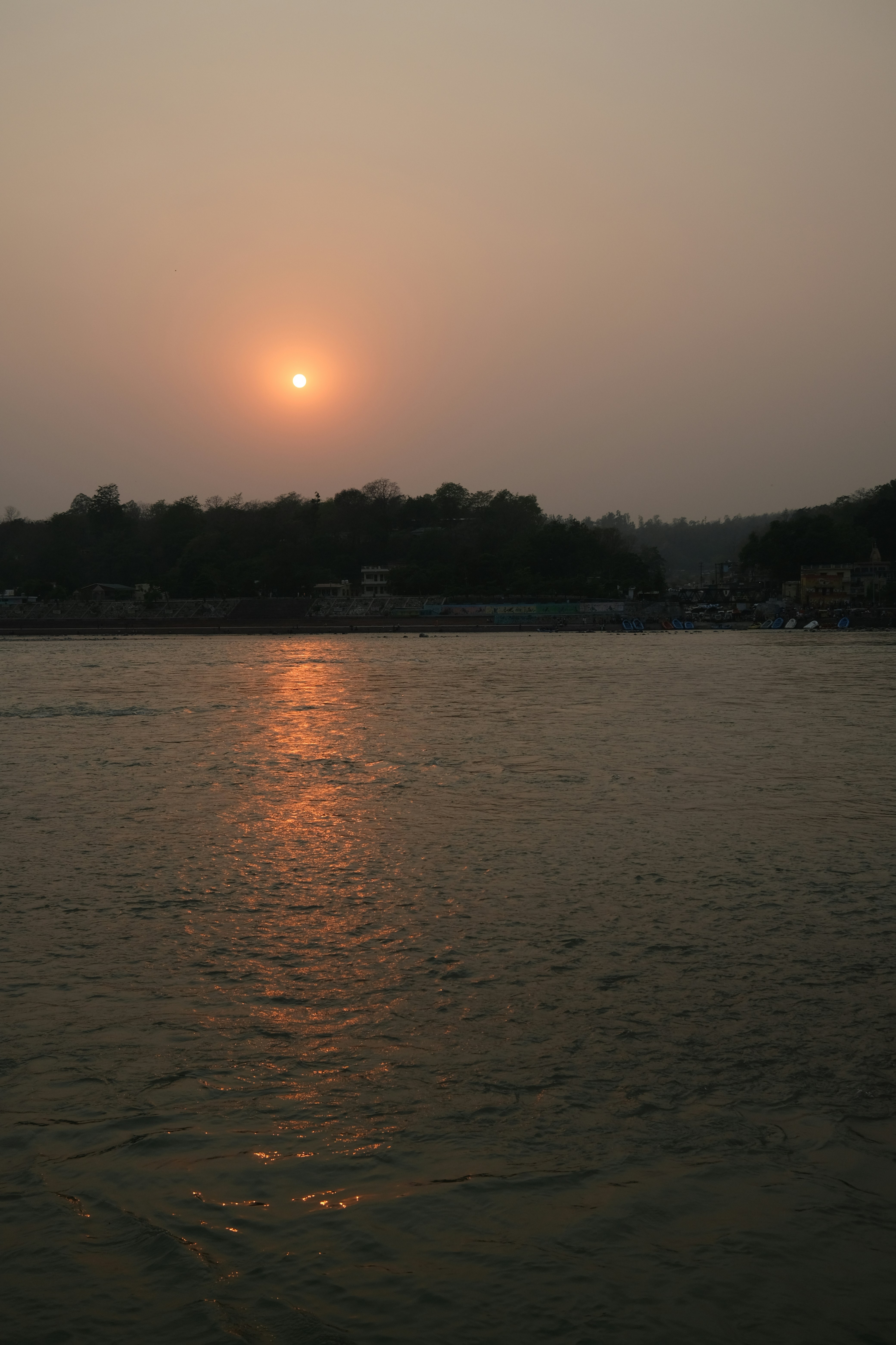 Amber Sun over a Quiet Riverside at Dusk