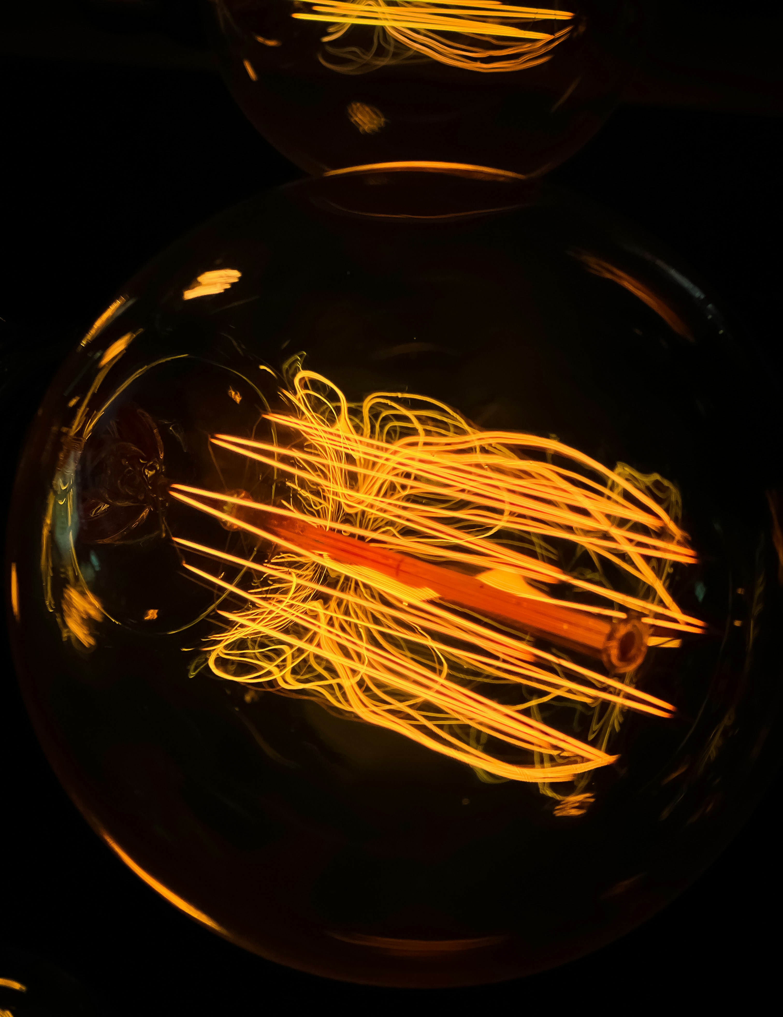 Tangled Lumen: A Close-Up of an Edison Filament Within a Glass Orb