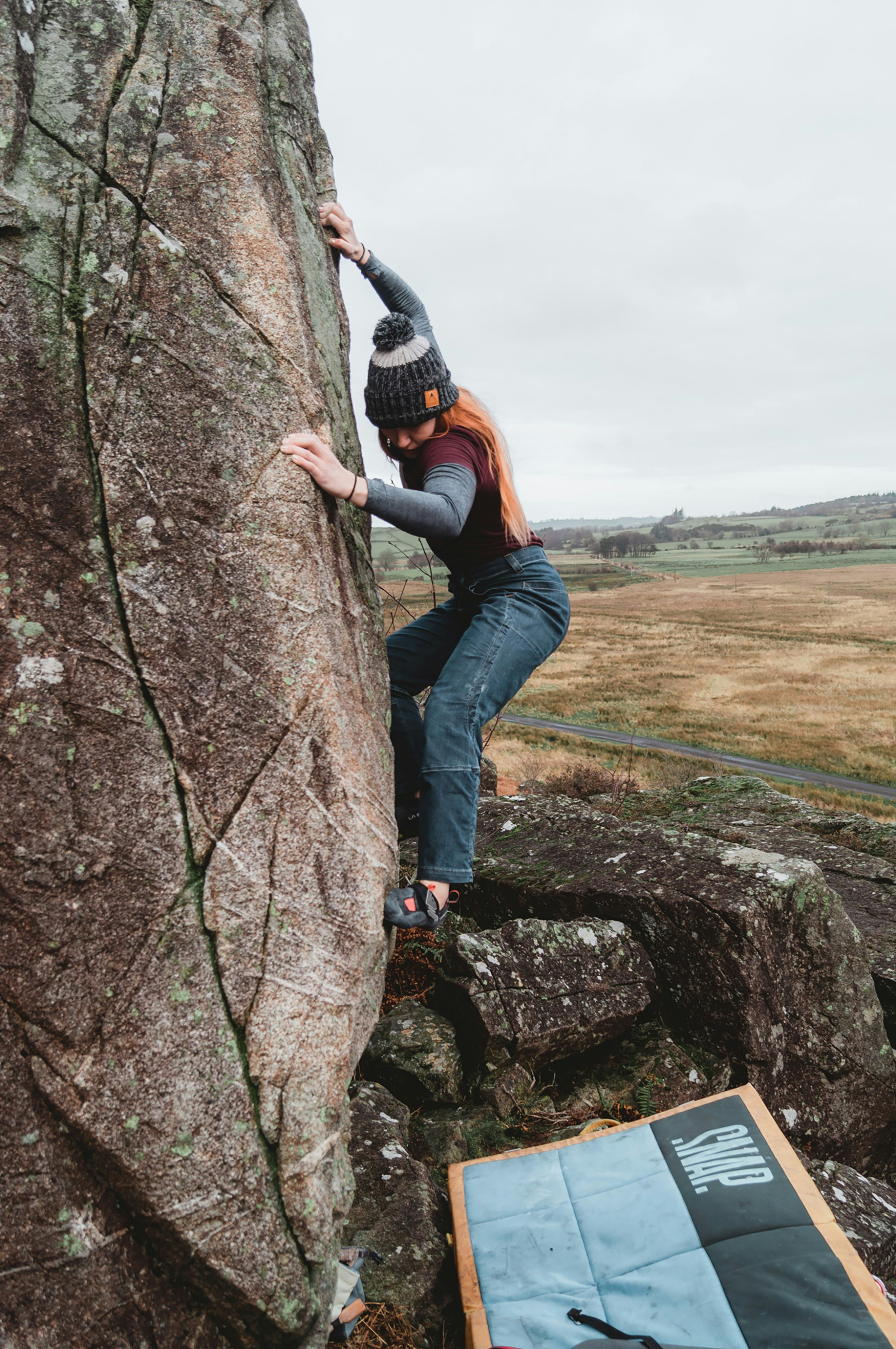 Cliffside Ascent: A climber caches resolve on a rugged escarpment