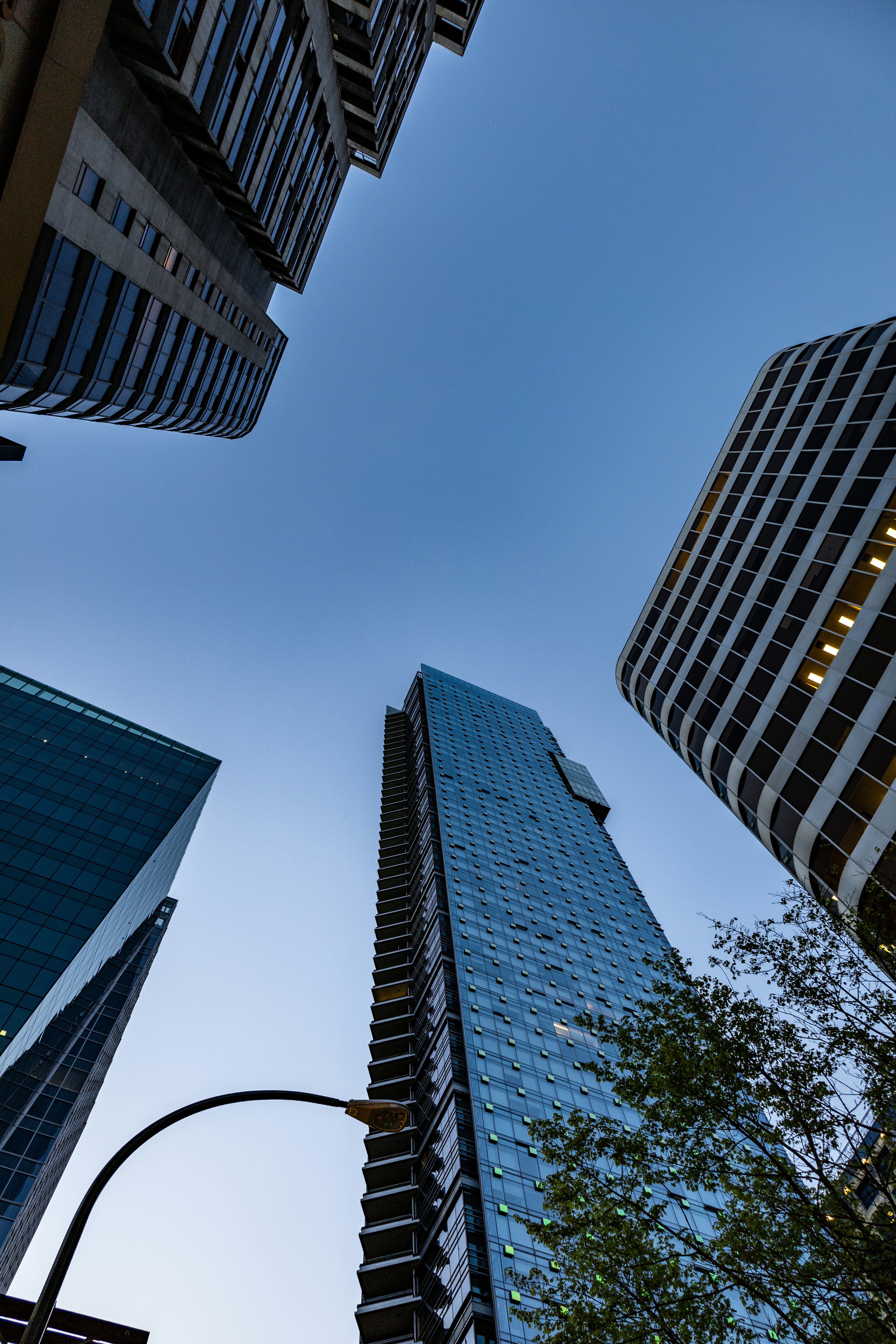 Looking up at tall buildings in a city photo – Free Blue Image on Unsplash