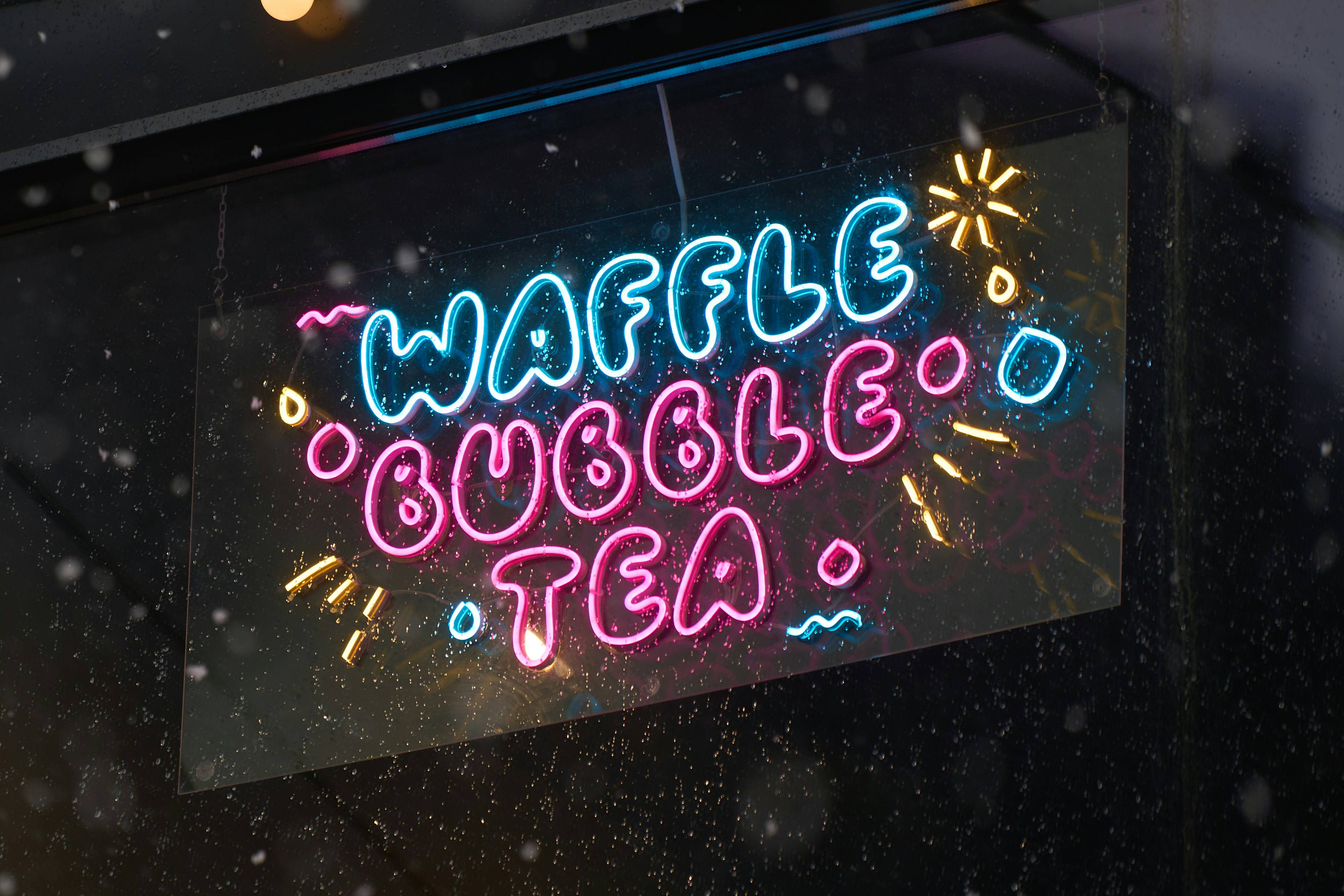 A neon sign that says waffles bubble tea photo – Free Light Image on ...