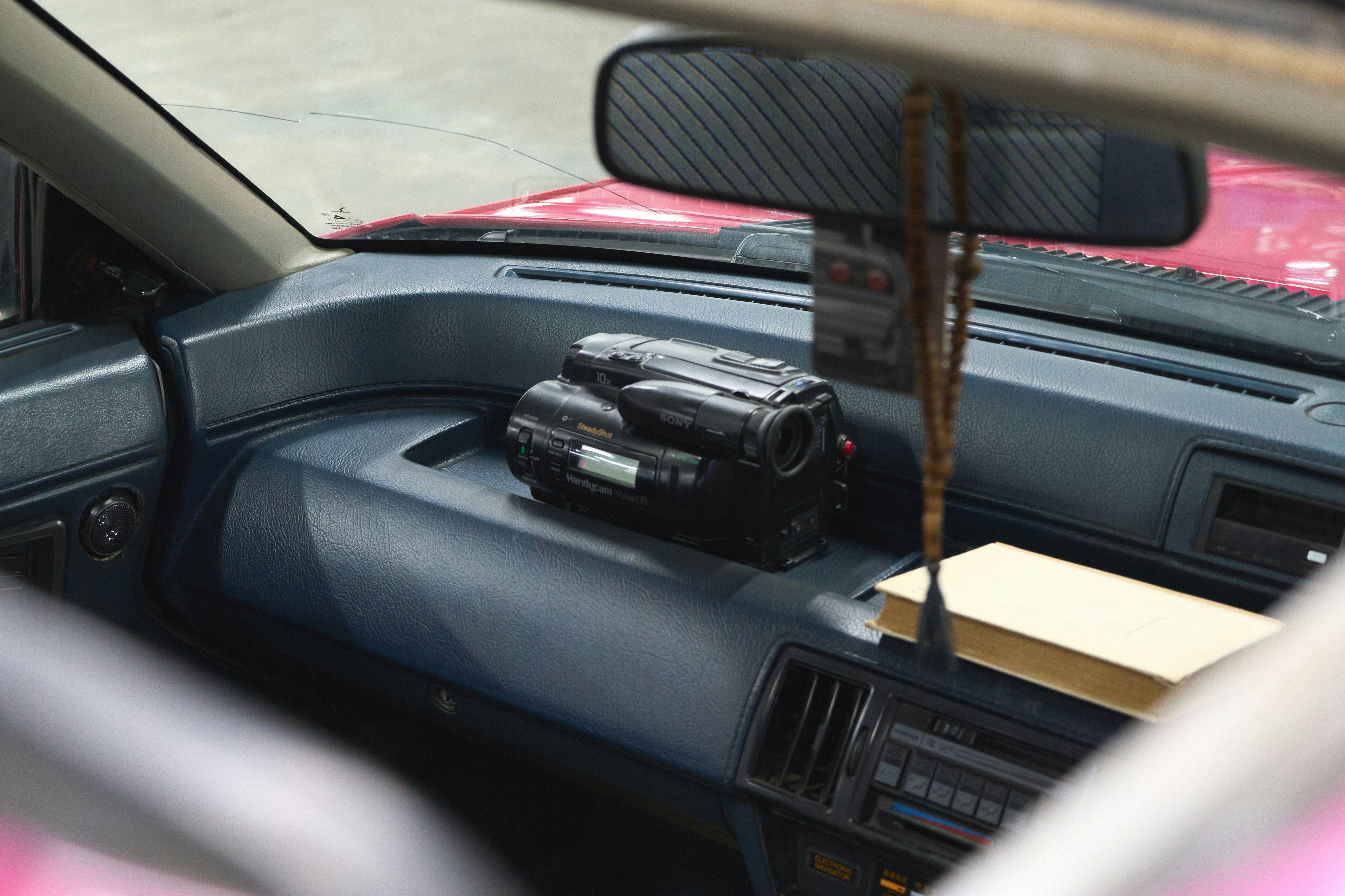 Dashcam Moments: A Hushed Interior with a Vintage Cam Resting on the Console