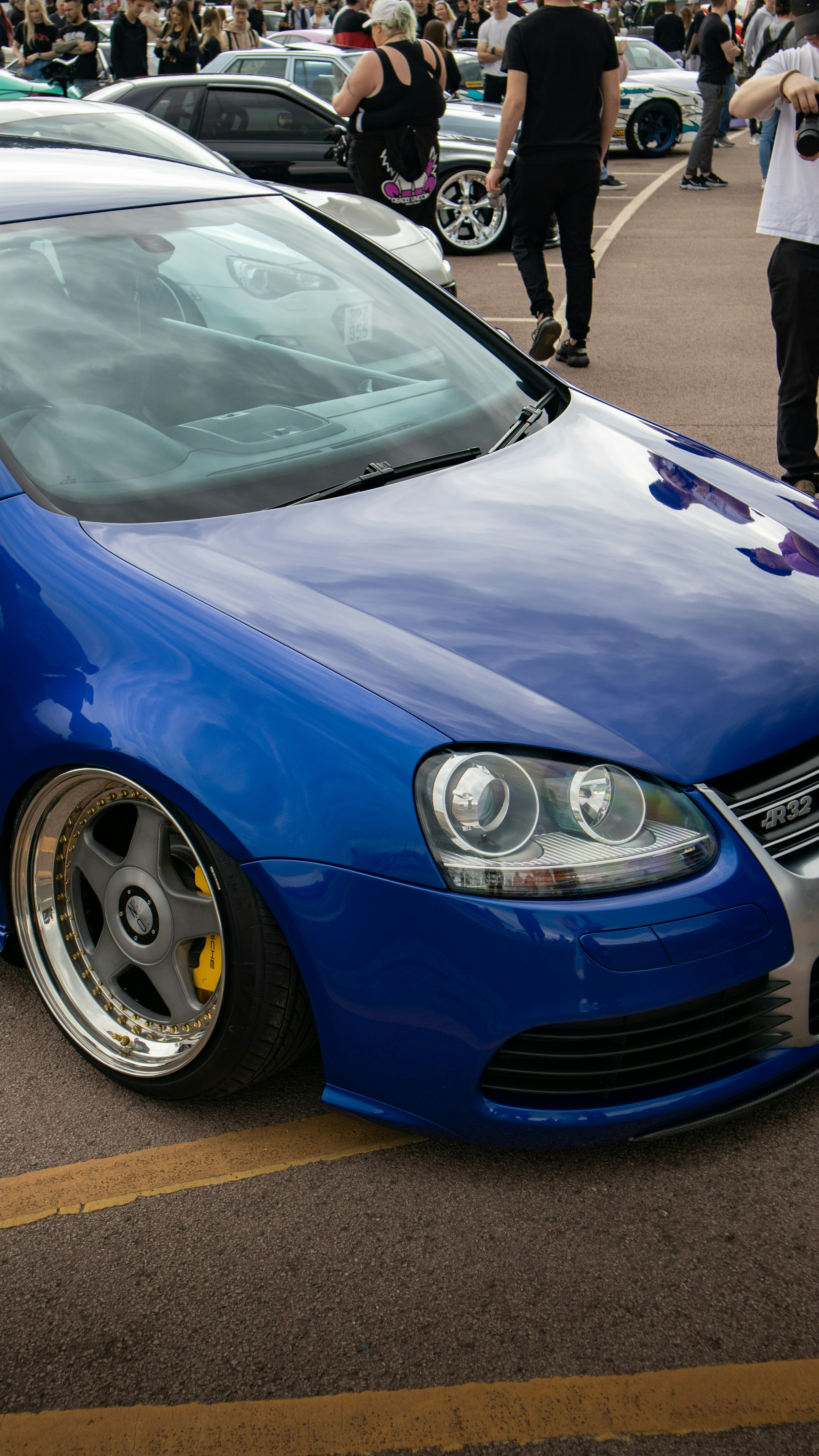 a blue car parked in a parking lot
