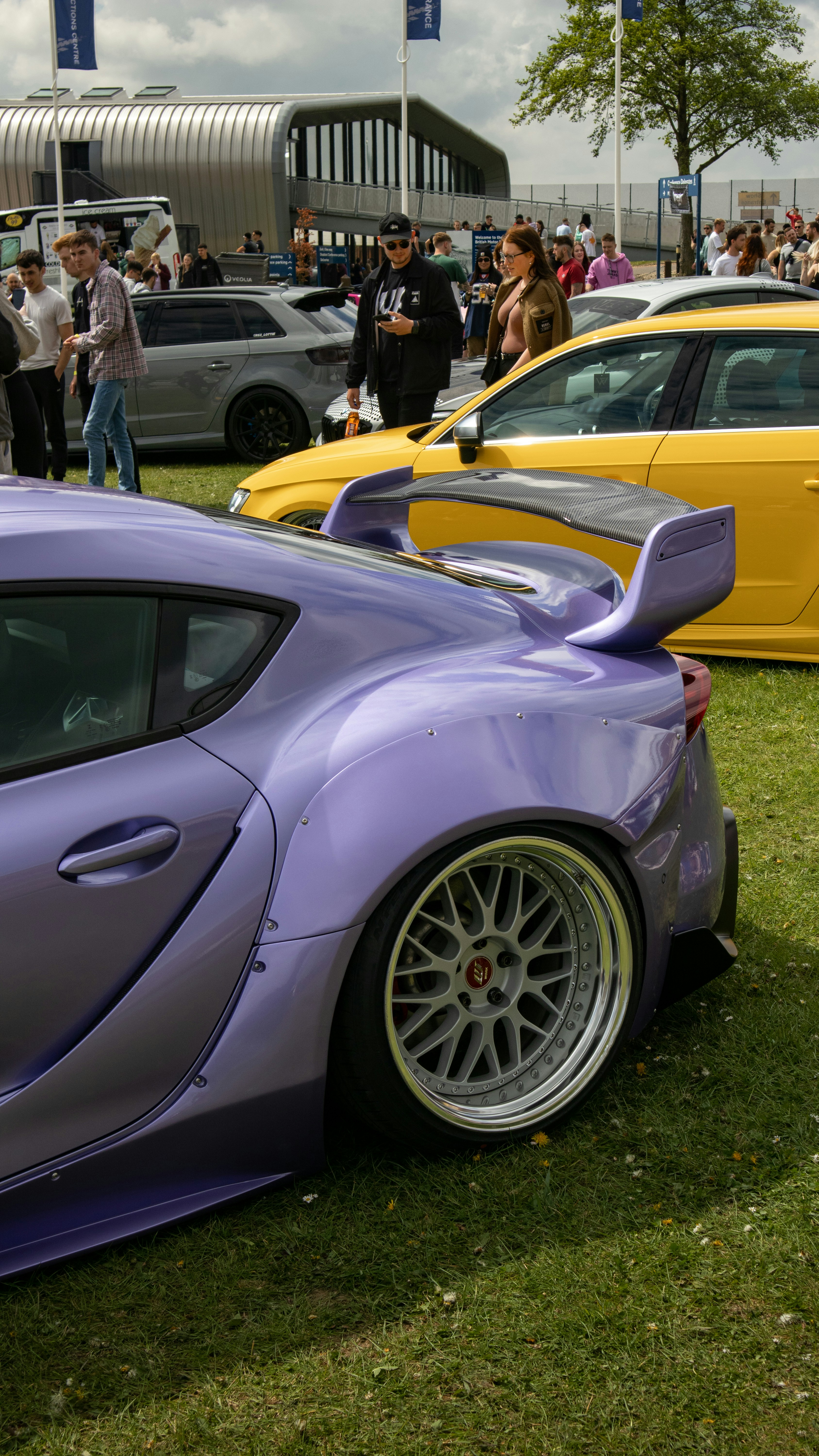 Lavender Velocity: Center-Stage Winged Beauty at a Car Show
