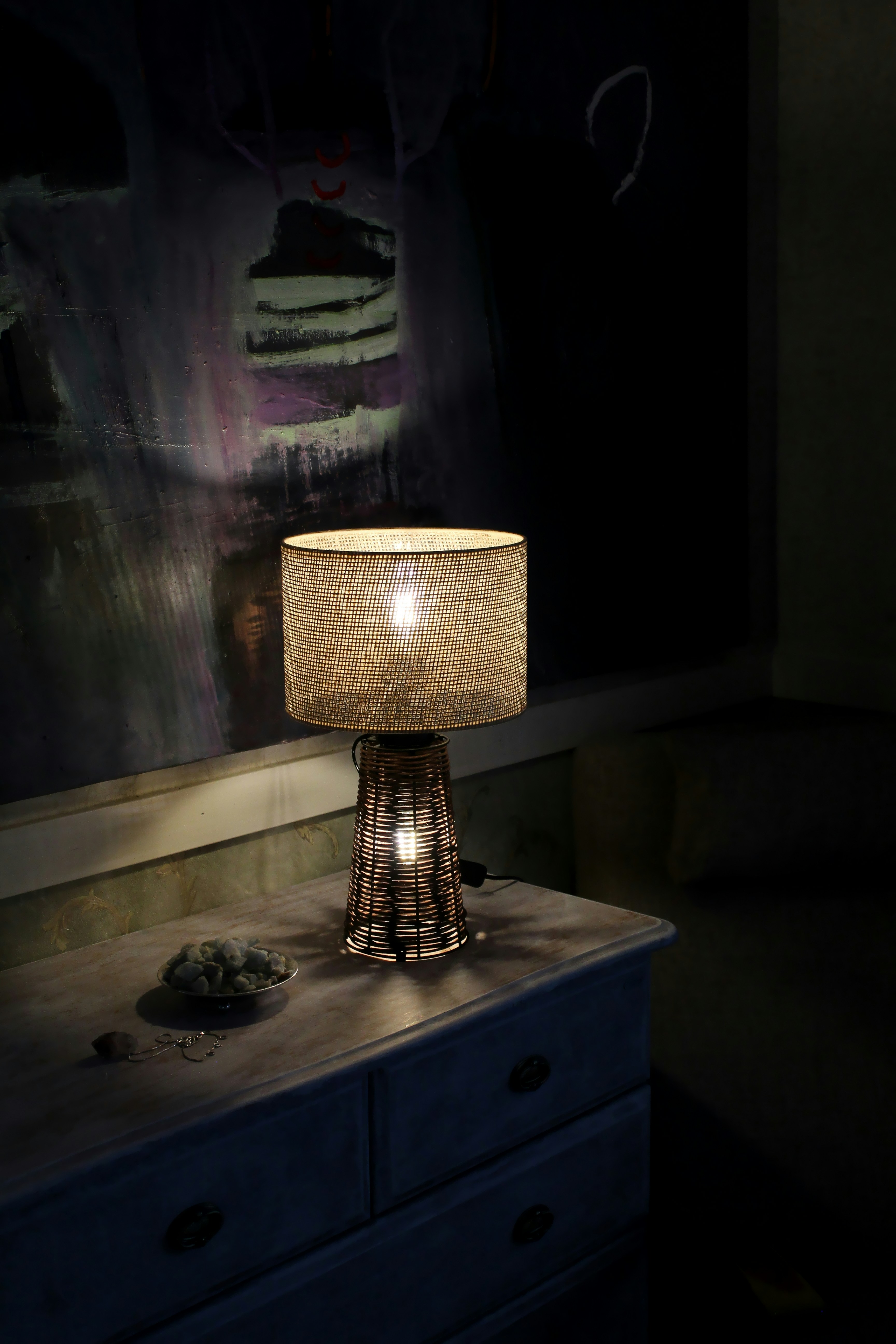 Woven Glow on a Moonlit Dresser: A Lamp's Quiet Presence